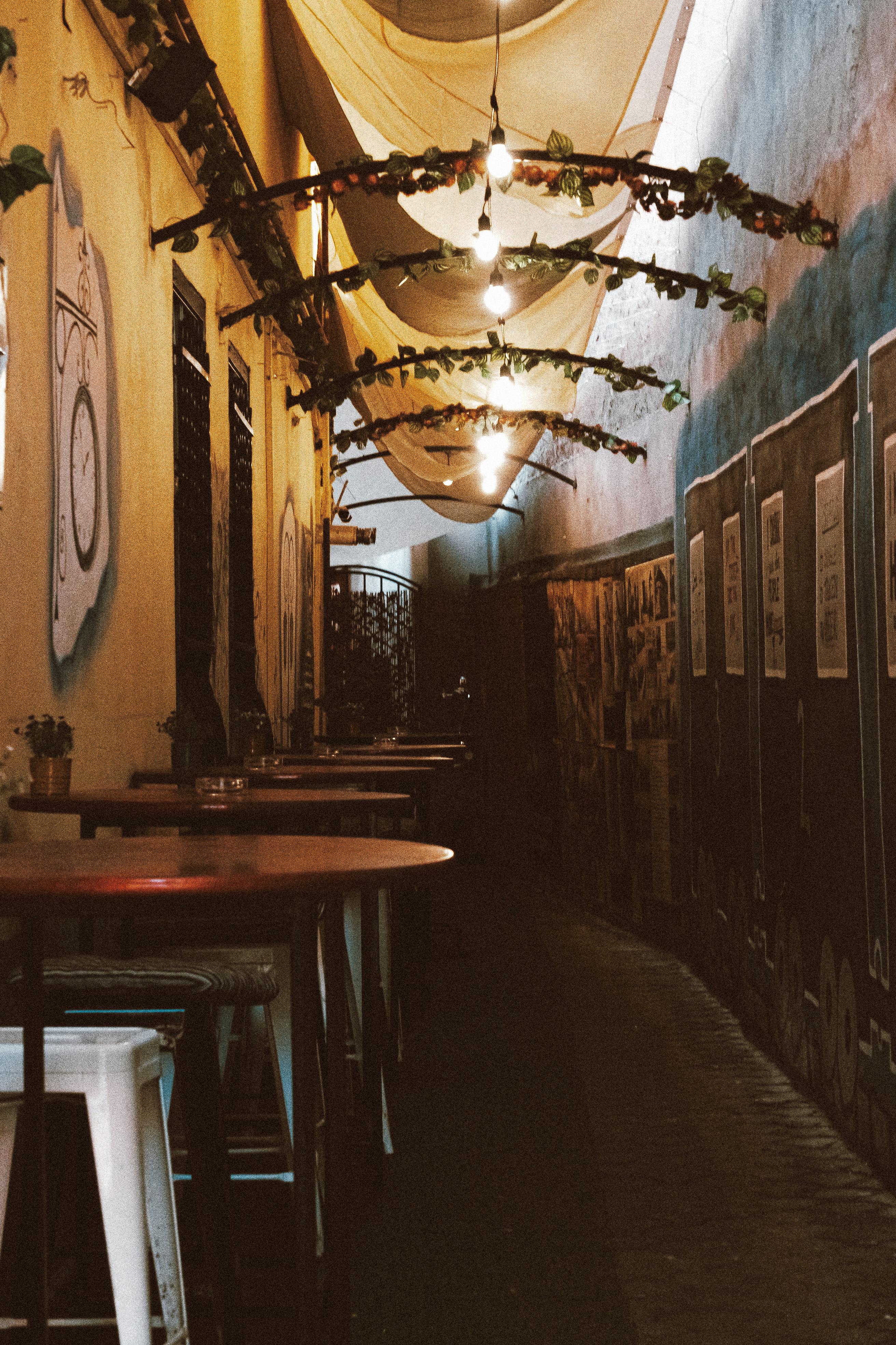 Tables and Chairs on a Narrow Dining Area · Free Stock Photo