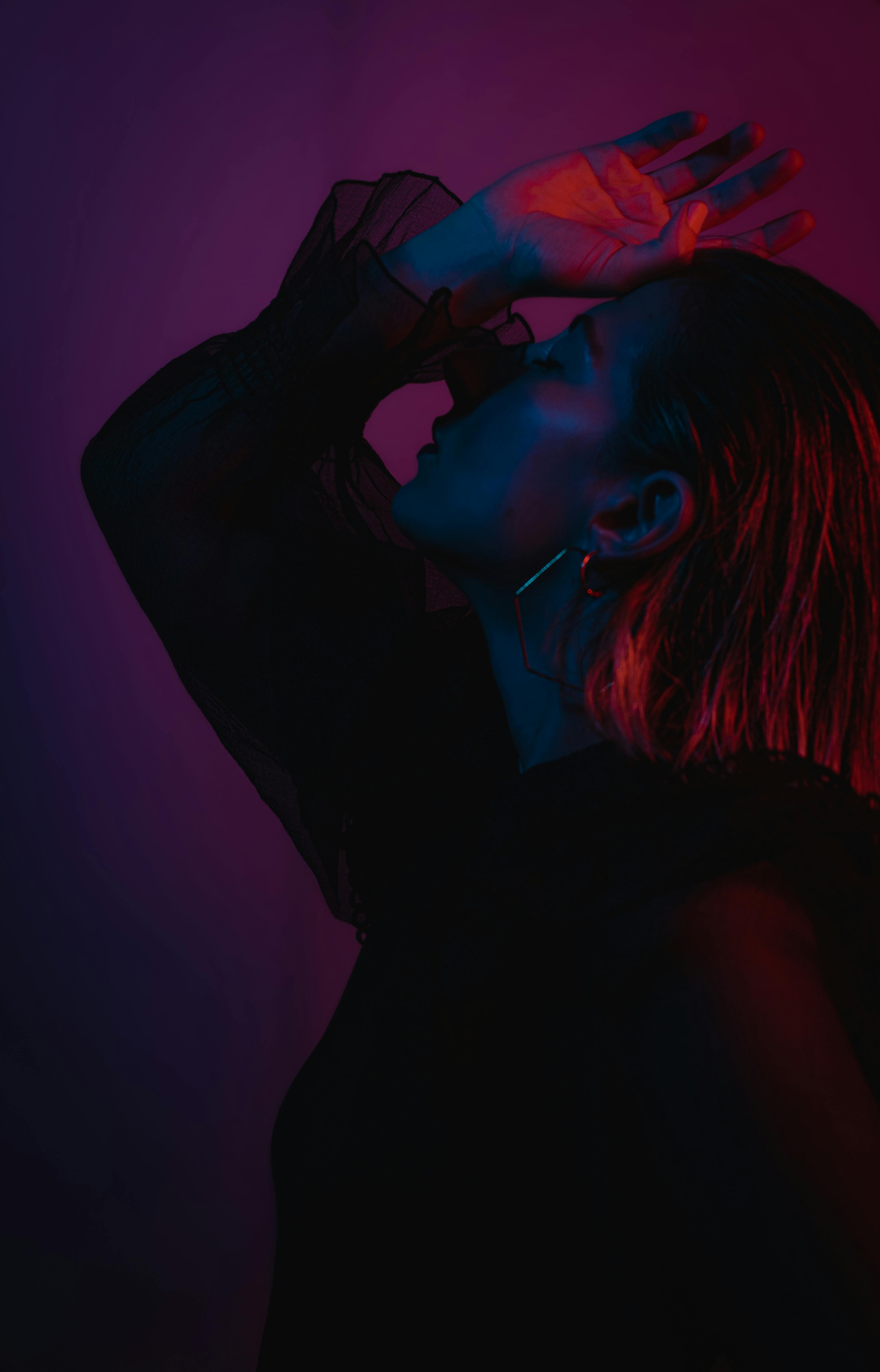 Woman With Red Light Reflection on Face · Free Stock Photo