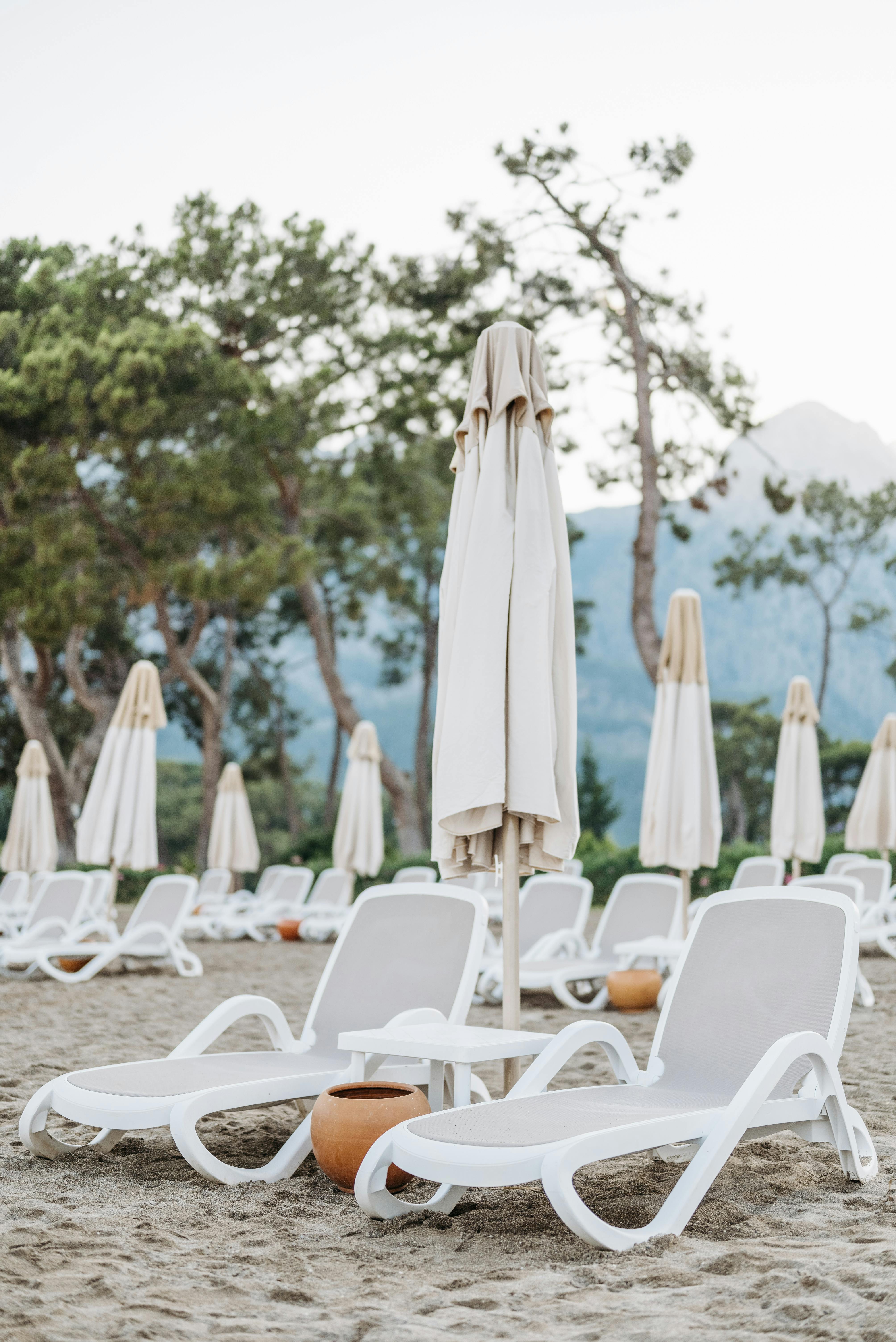 White Plastic Beach Chairs on White Sand · Free Stock Photo