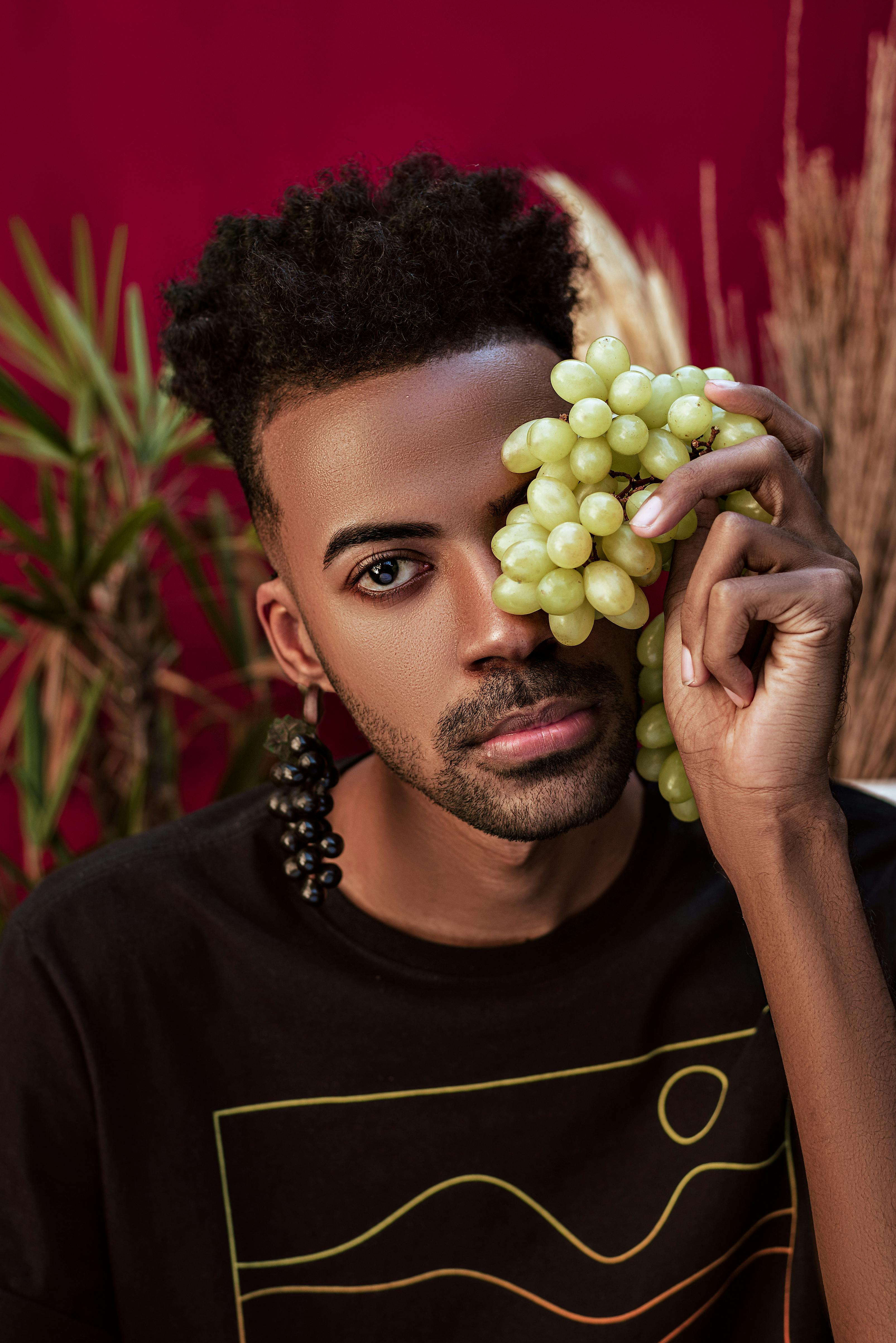 Man in Black Crew Neck Shirt Holding Green Grapes · Free Stock Photo