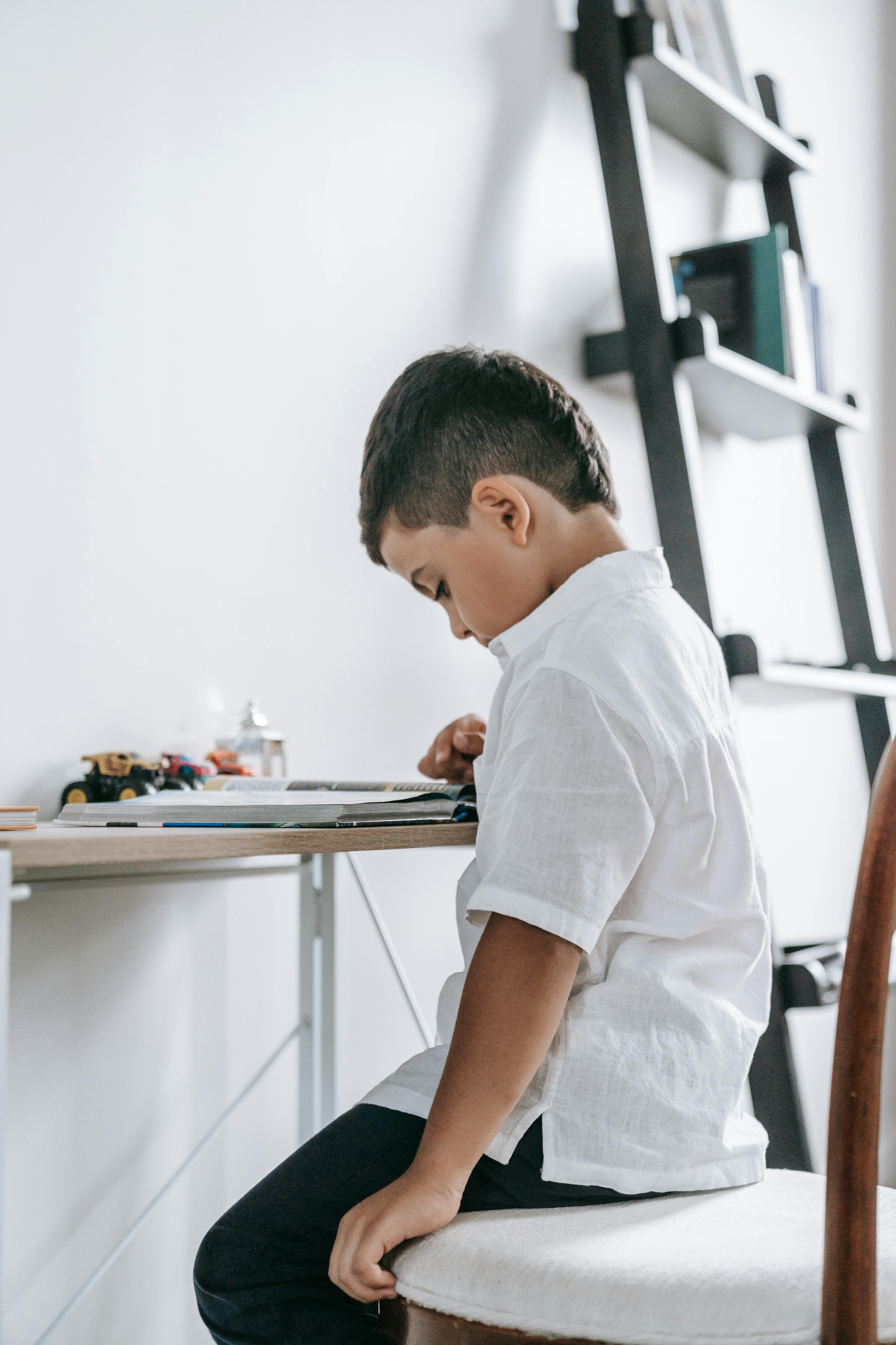 A Boy Sitting at the Table · Free Stock Photo