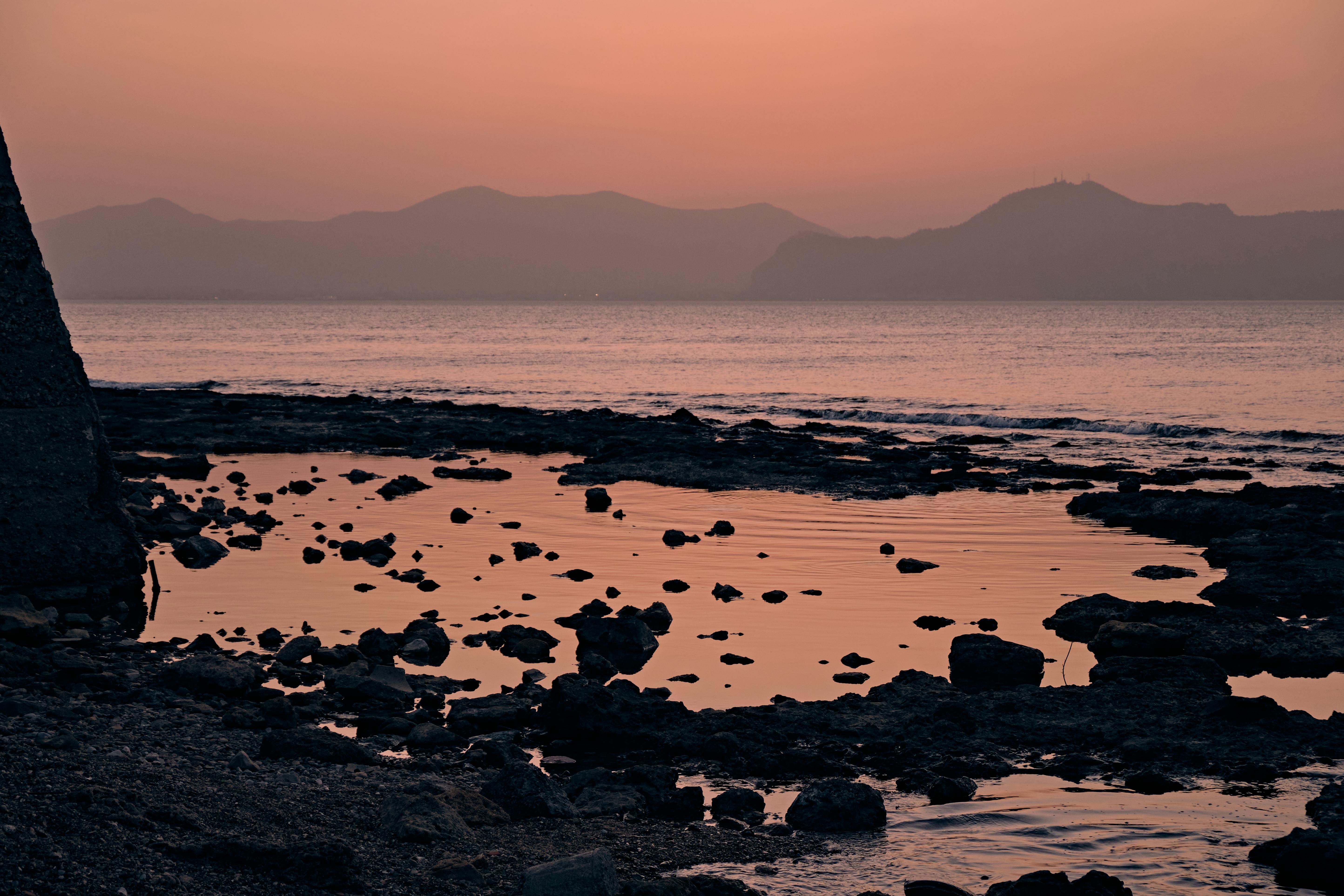 Black Rocks on Sea Shore · Free Stock Photo