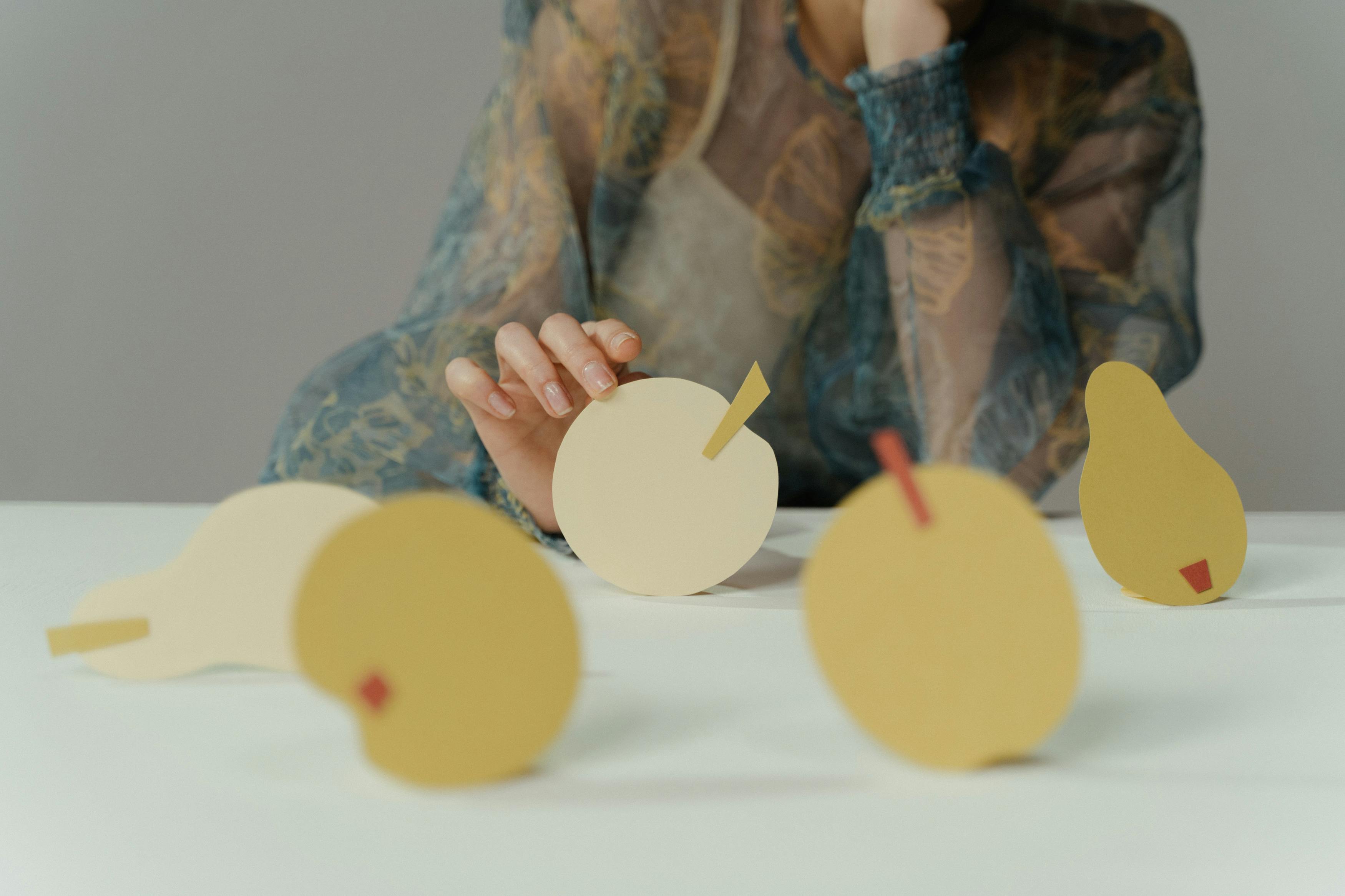 Hand Holding a Yellow Pear Paper Craft · Free Stock Photo