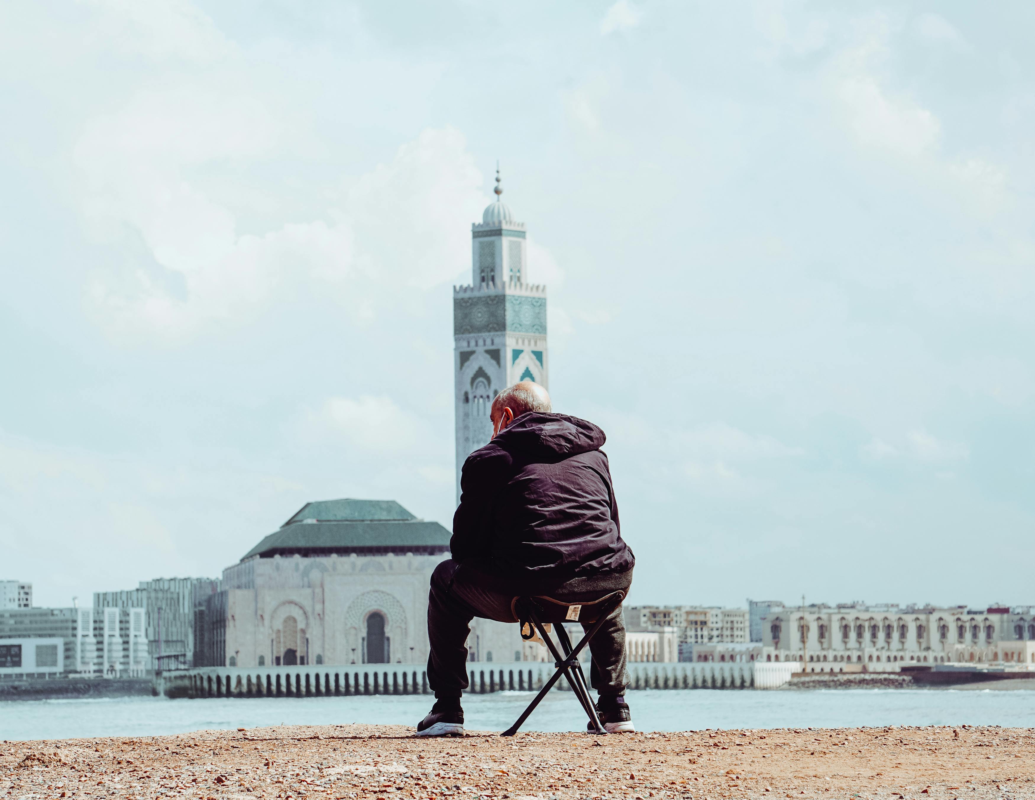 Man Standing Under An Arch Of Building · Free Stock Photo