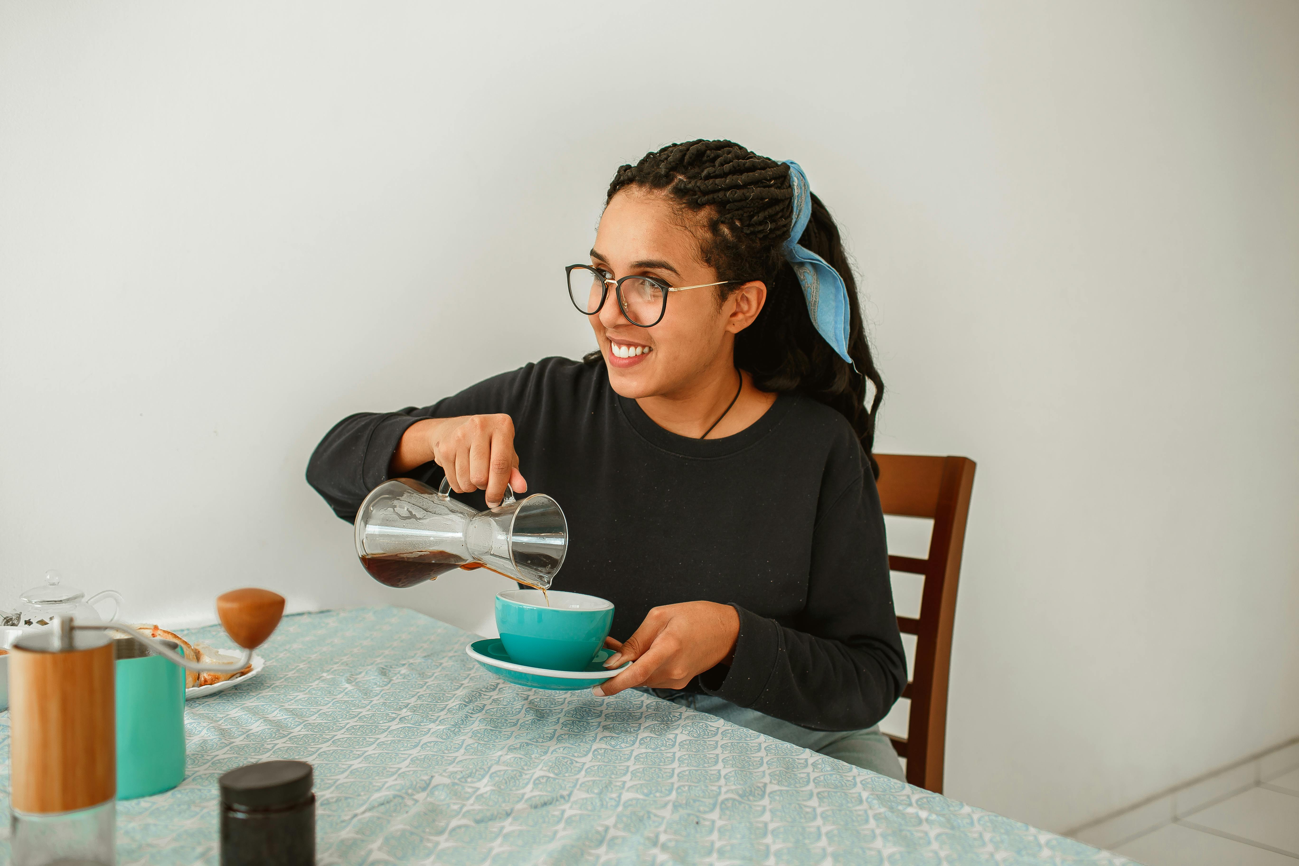 Woman Pouring Tea on Cup · Free Stock Photo