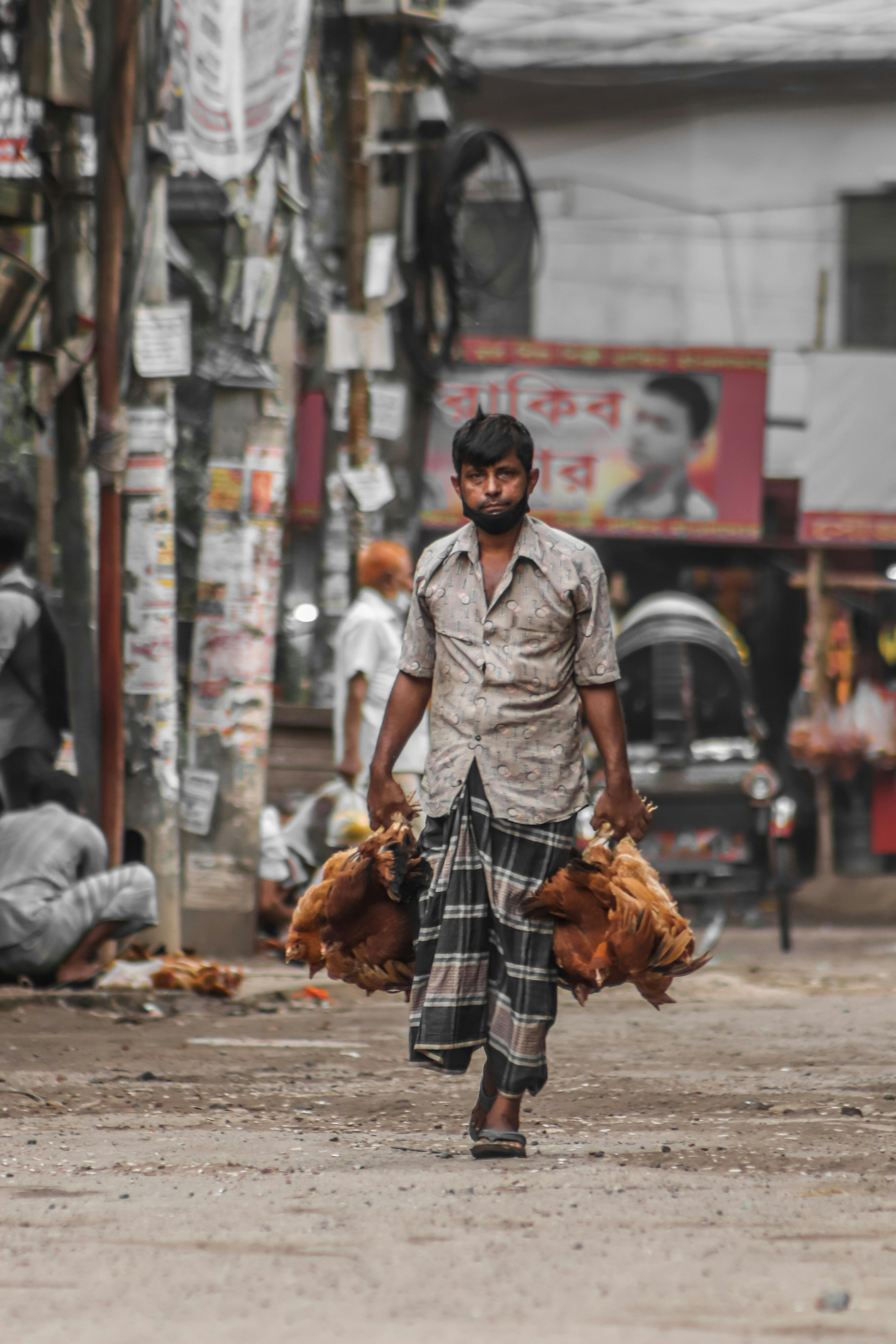 Disabled Man carrying Chickens · Free Stock Photo