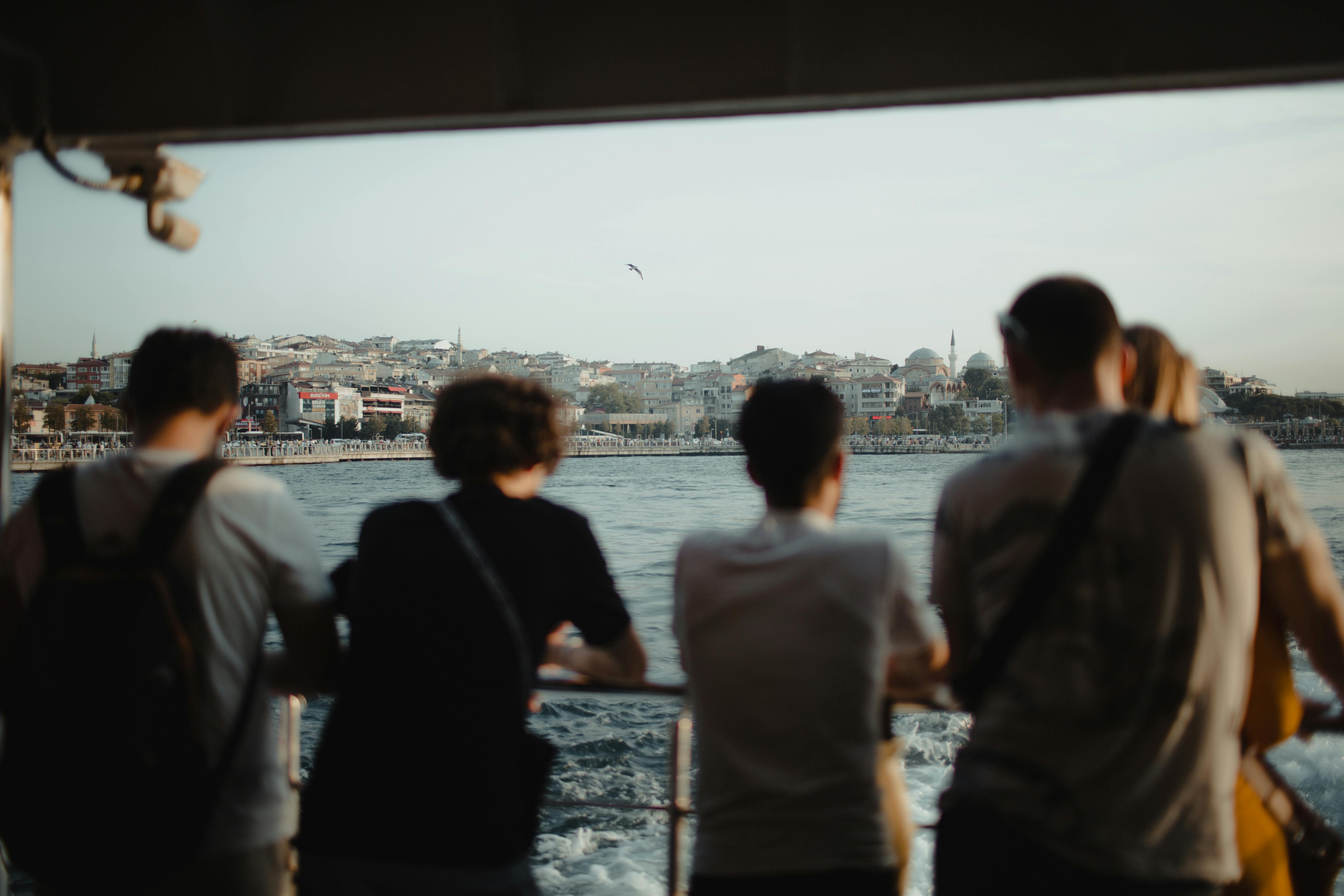 Back View of People Standing Near the Taffrail · Free Stock Photo