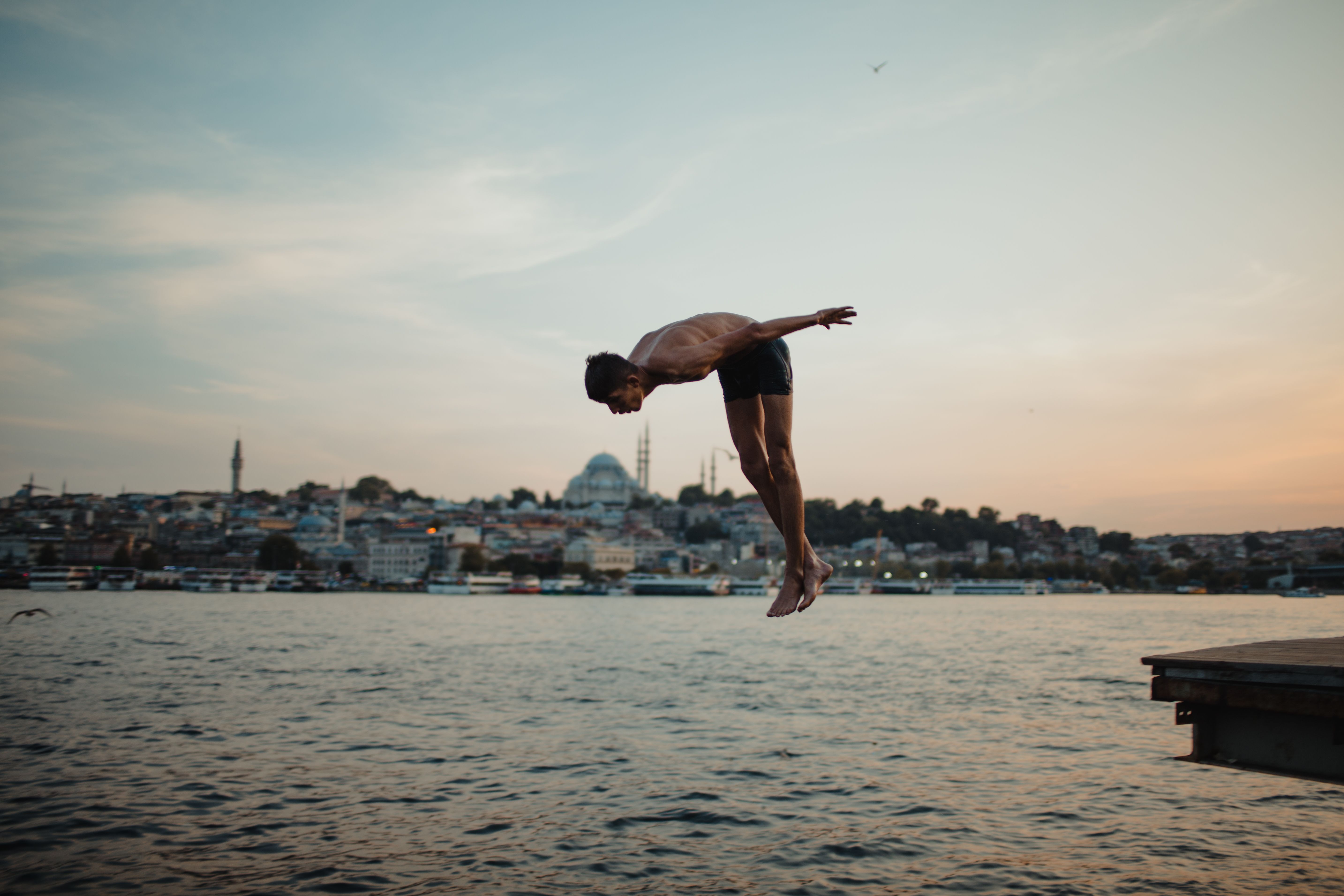 A Shirtless Man Diving on Water · Free Stock Photo