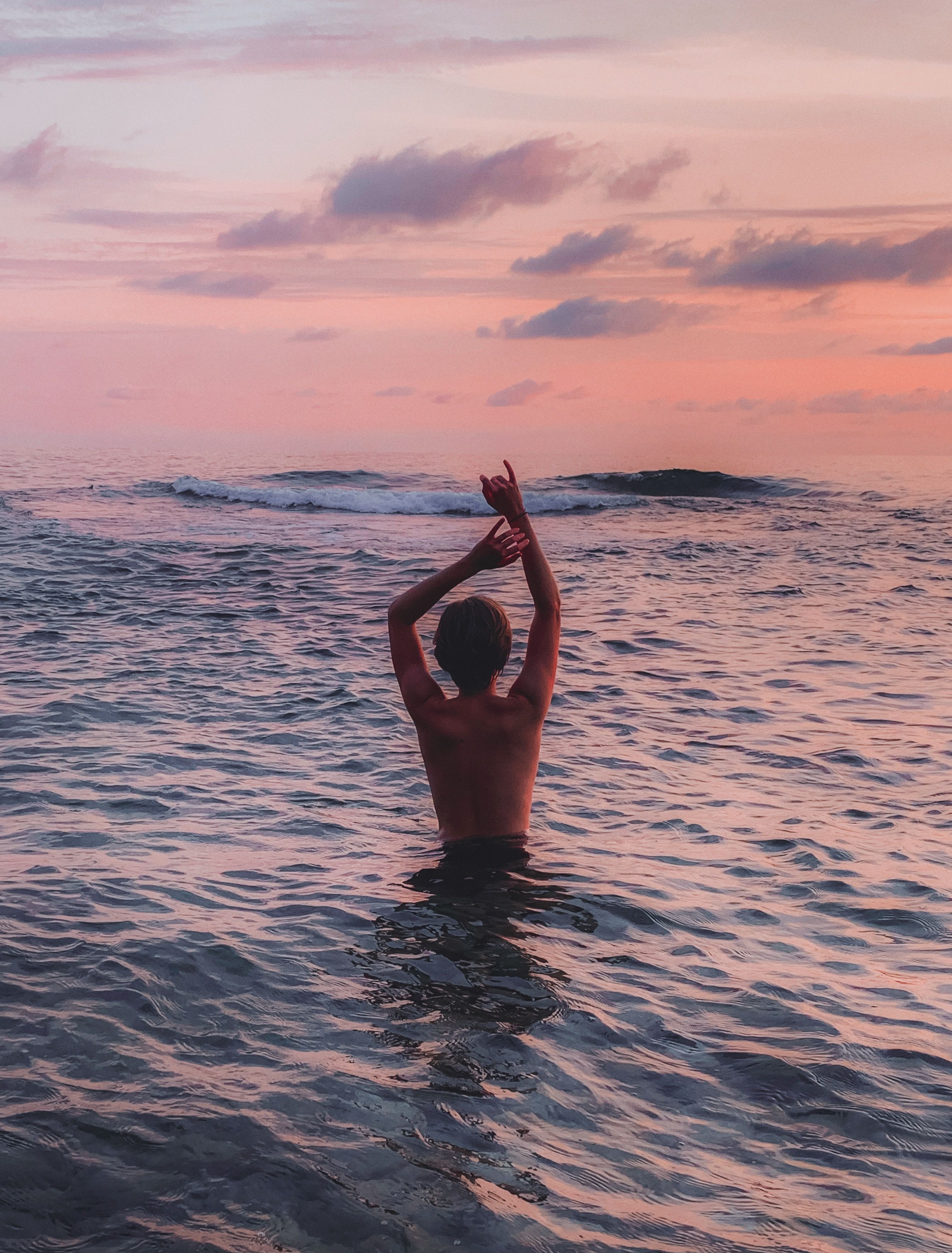 A Woman on a Beach at Sunset · Free Stock Photo