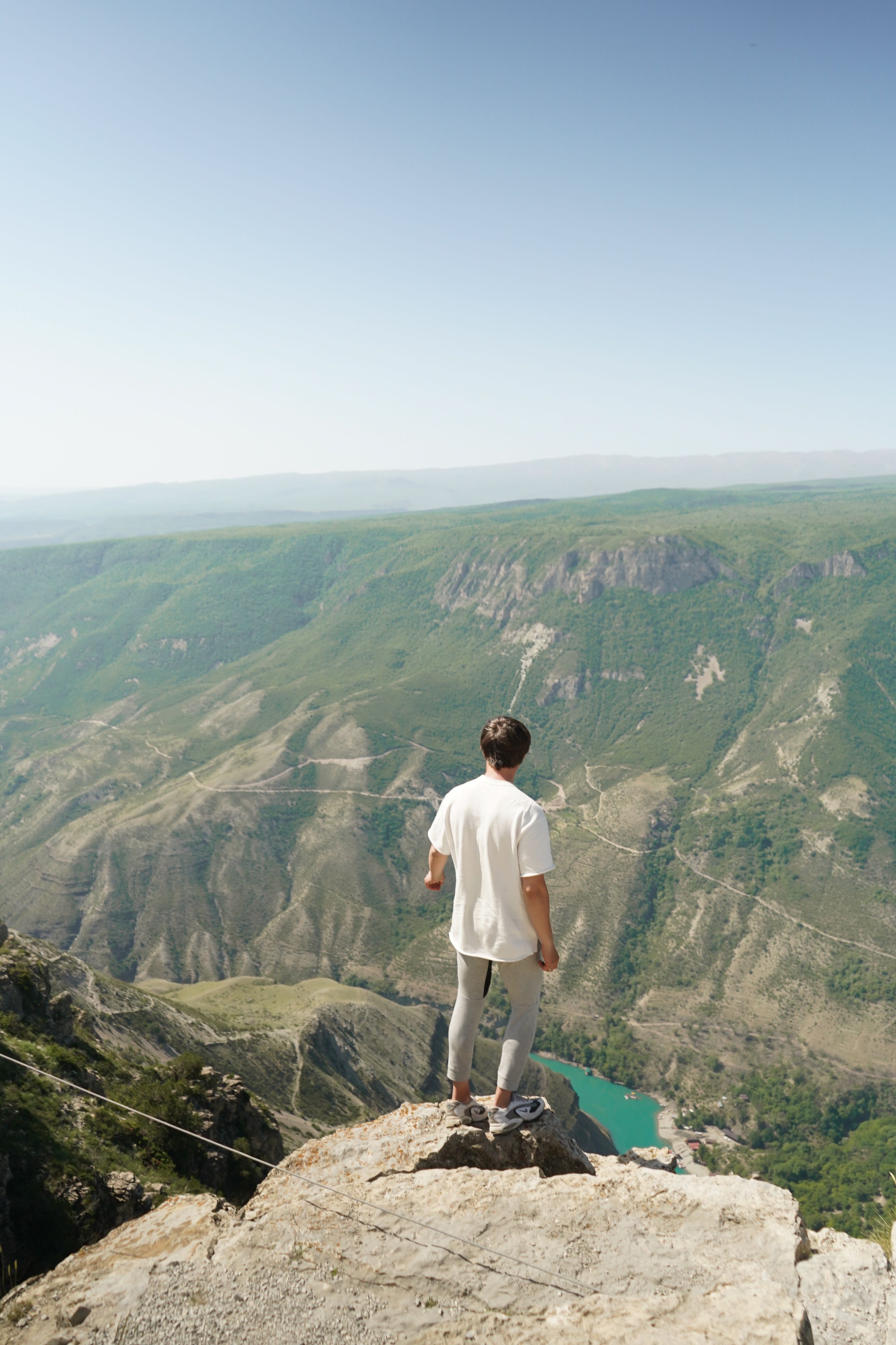 Back View of a Man Standing on Mountain Peak under the Sky · Free Stock ...