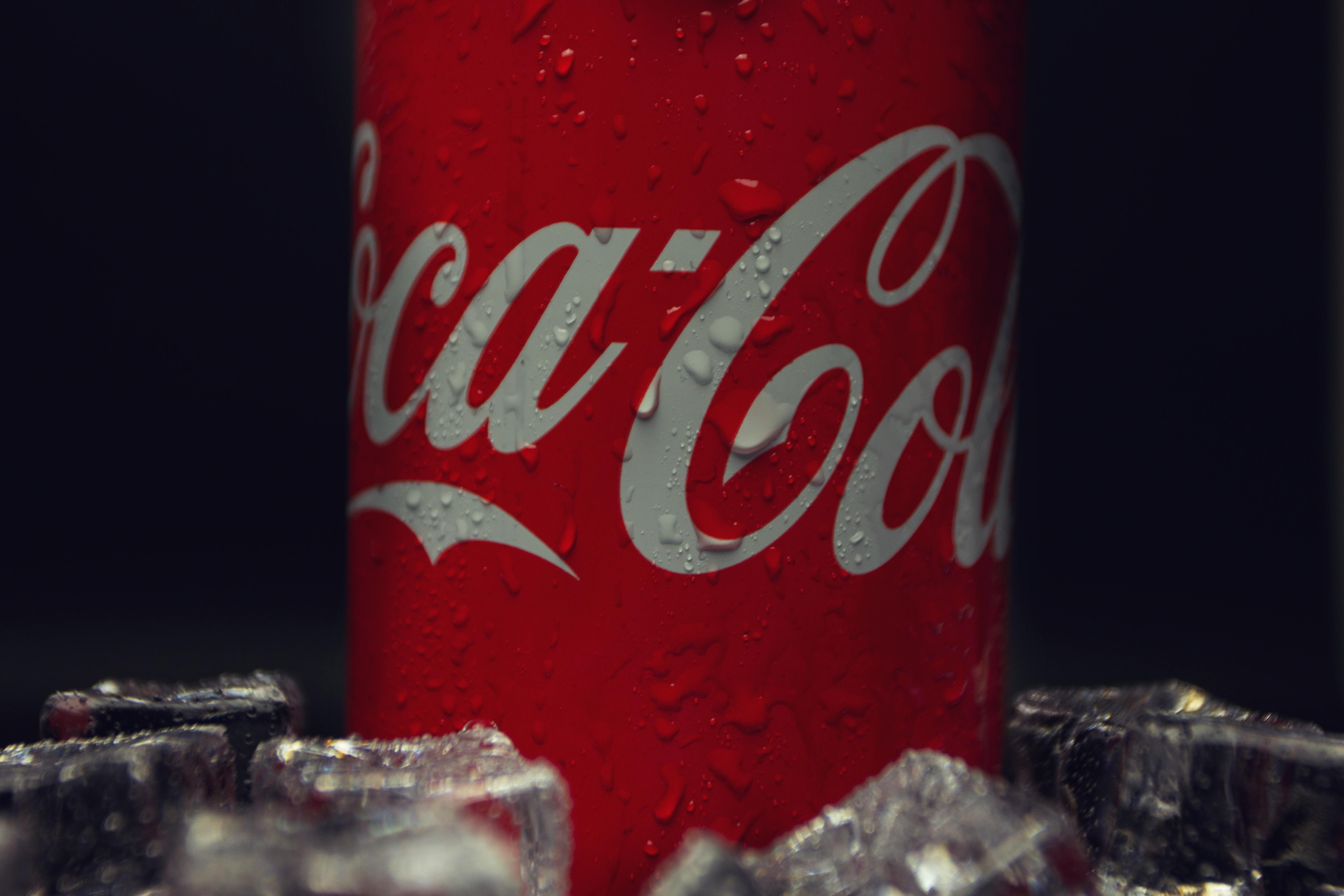 Coca Cola Cans on Black Surface · Free Stock Photo