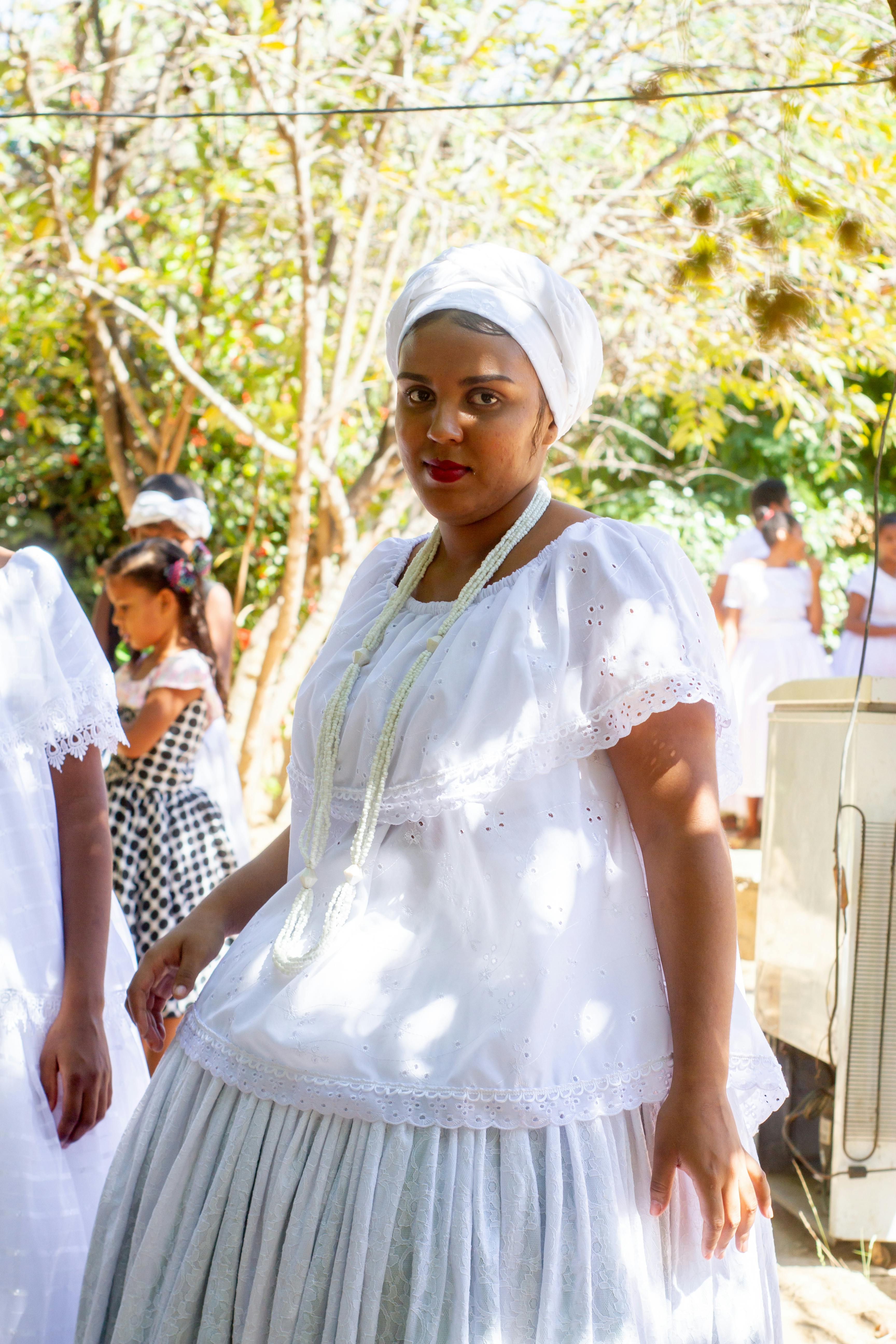 Woman in Green Traditional Dress Standing near Green Plant · Free Stock Photo