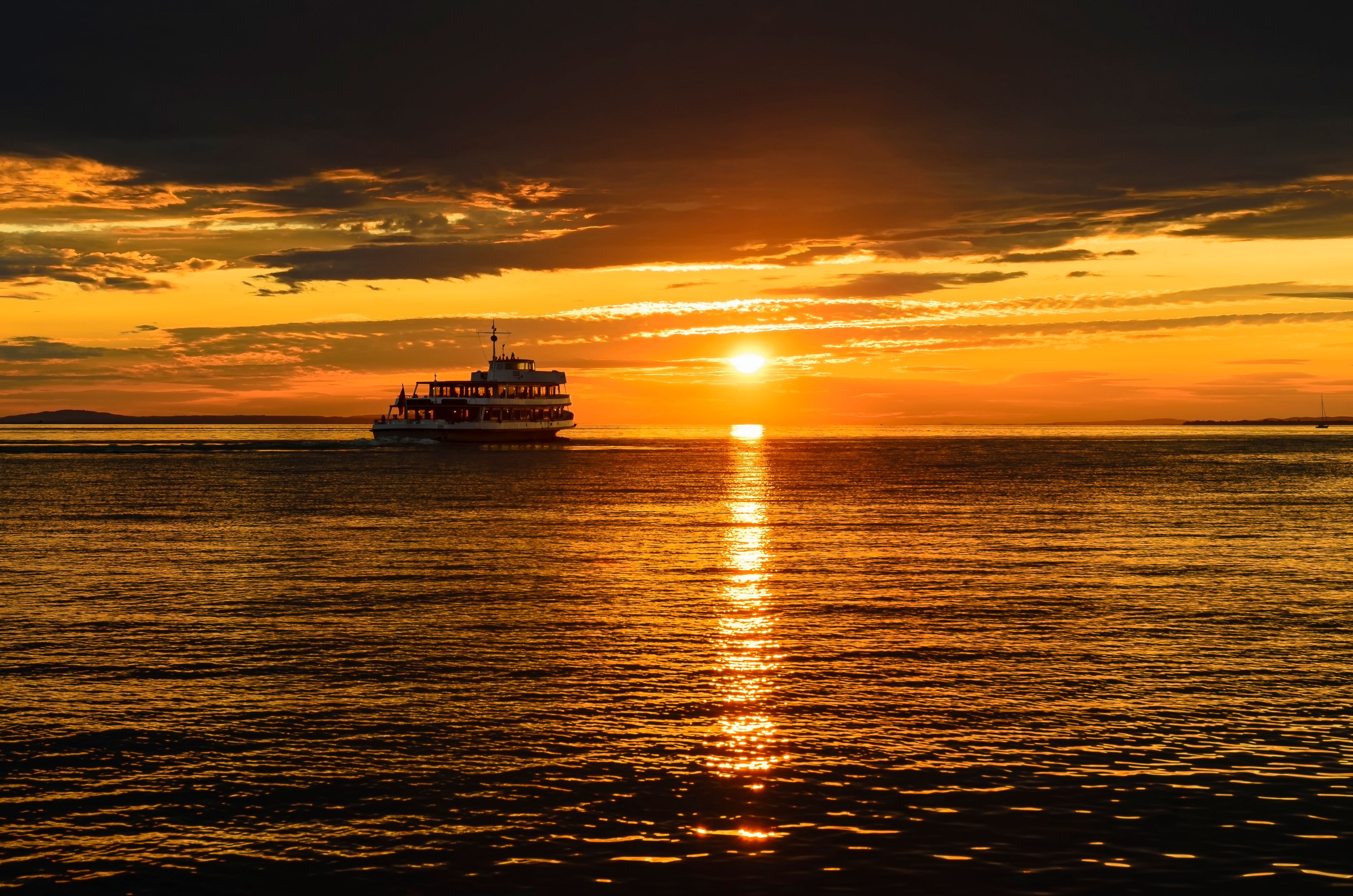 A Ferry Sailing on the Sea during Sunset · Free Stock Photo