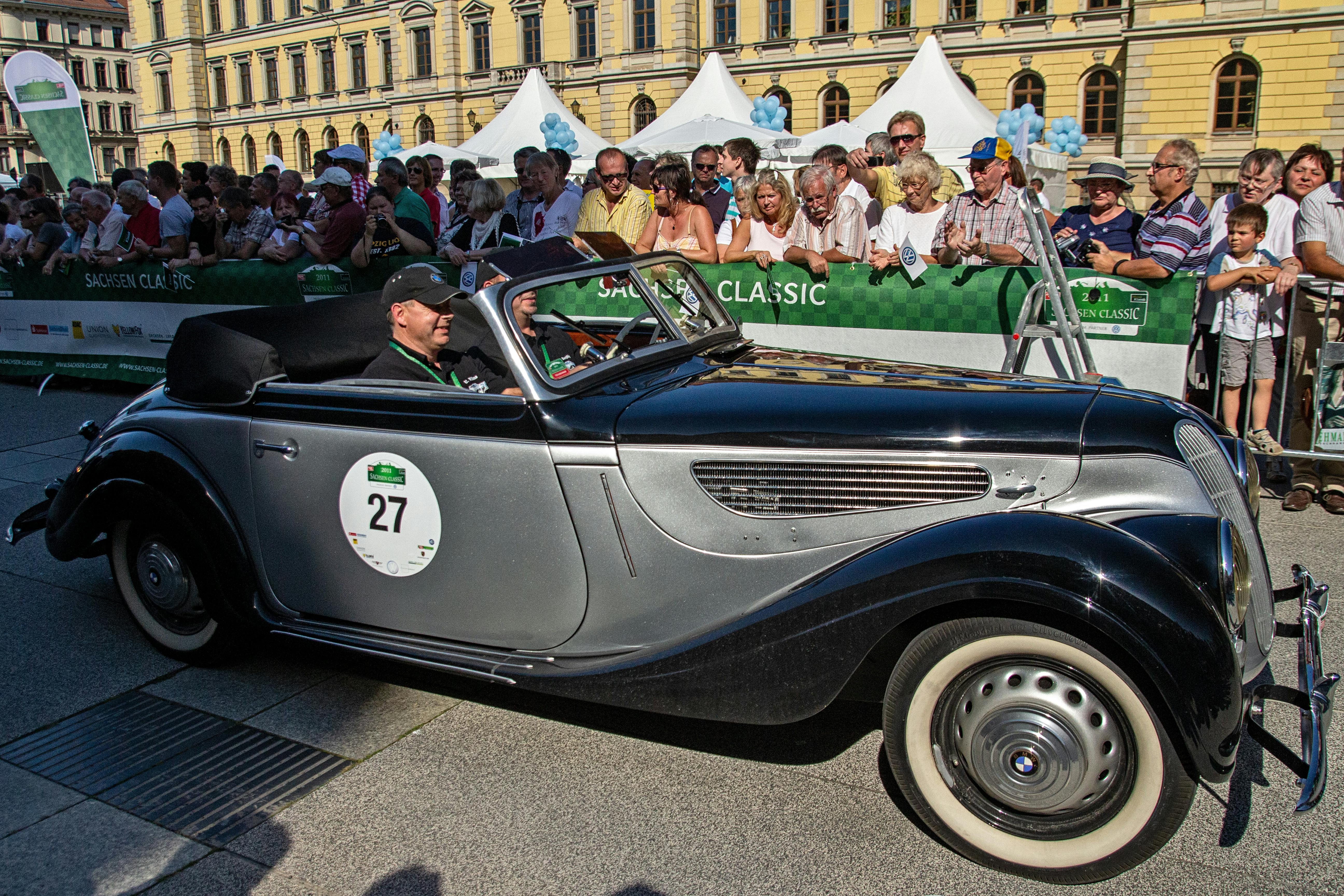 Two People Riding a Classic Car · Free Stock Photo