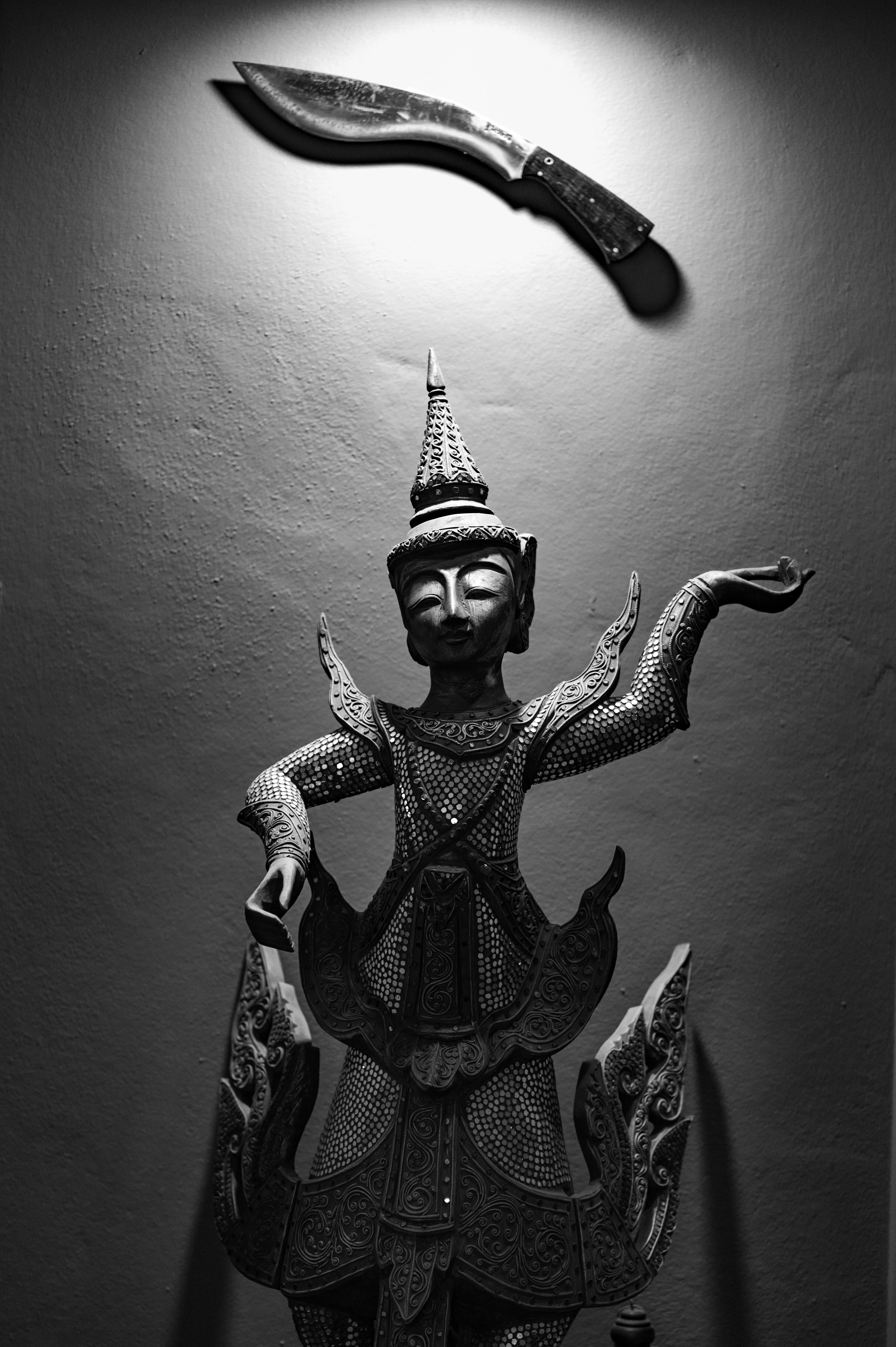 Buddha Figurine with a Sword in Black and White · Free Stock Photo