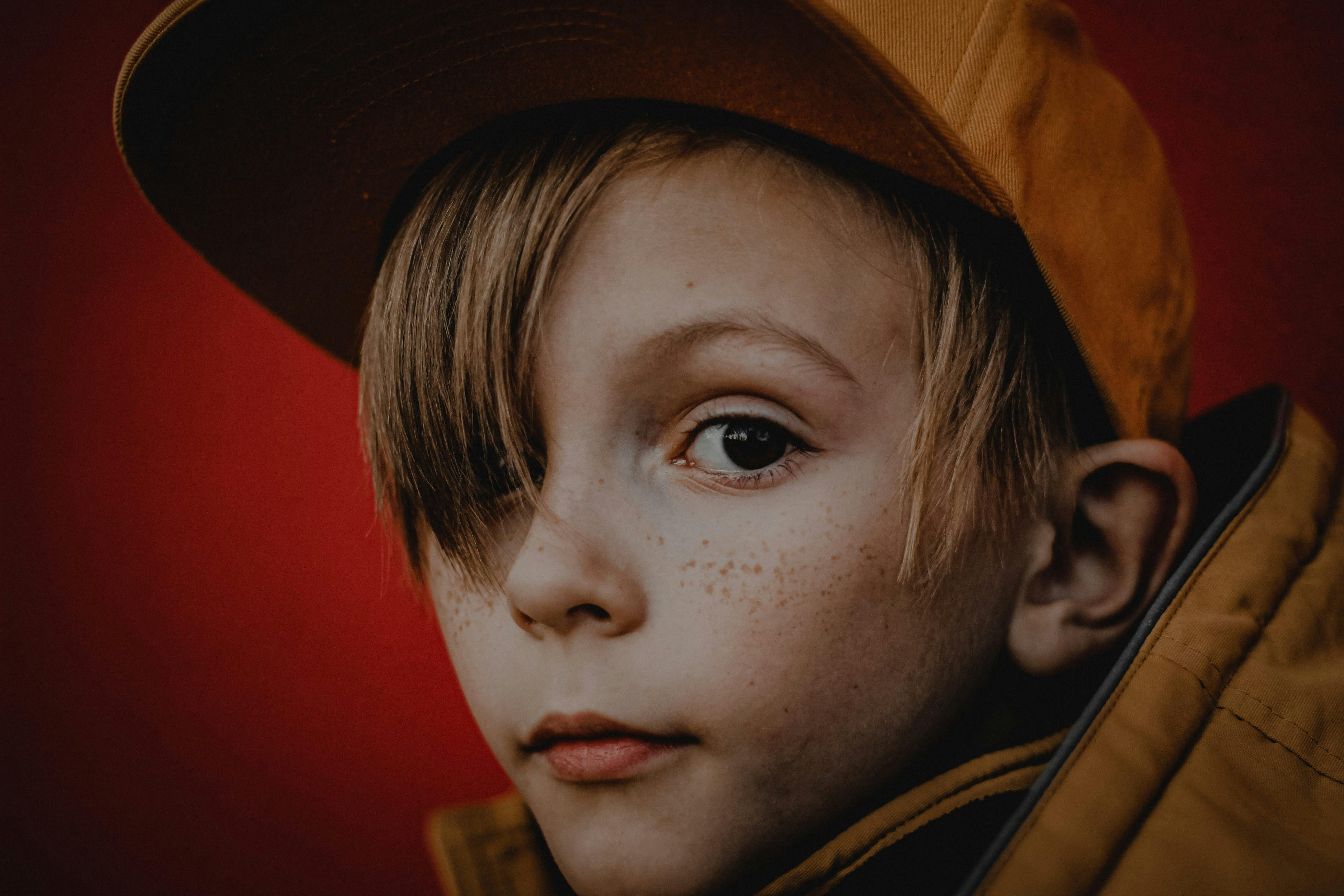 Close-Up Shot of a Boy Wearing a Cap · Free Stock Photo