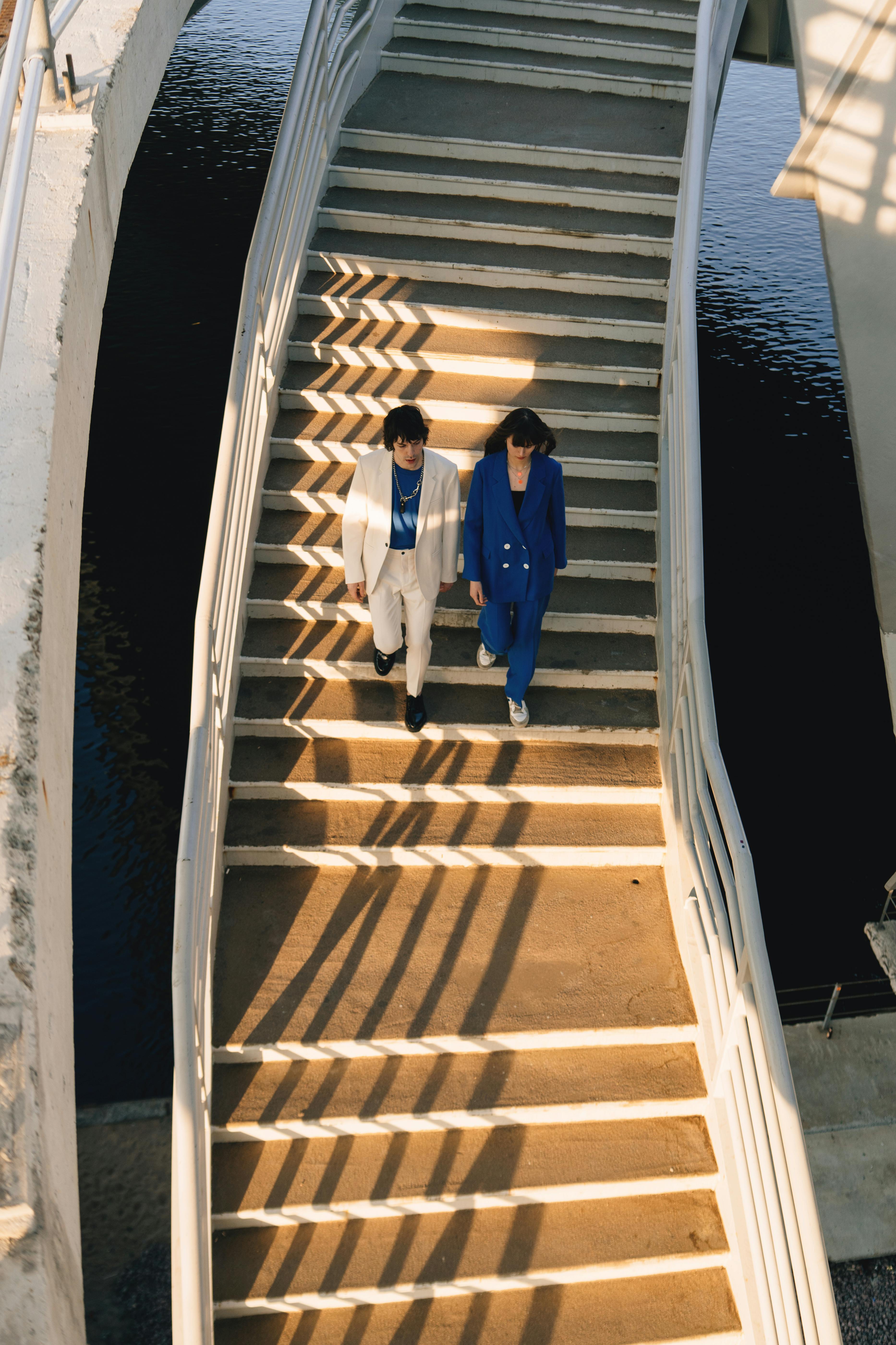 Elegant Couple Walking Downstairs · Free Stock Photo