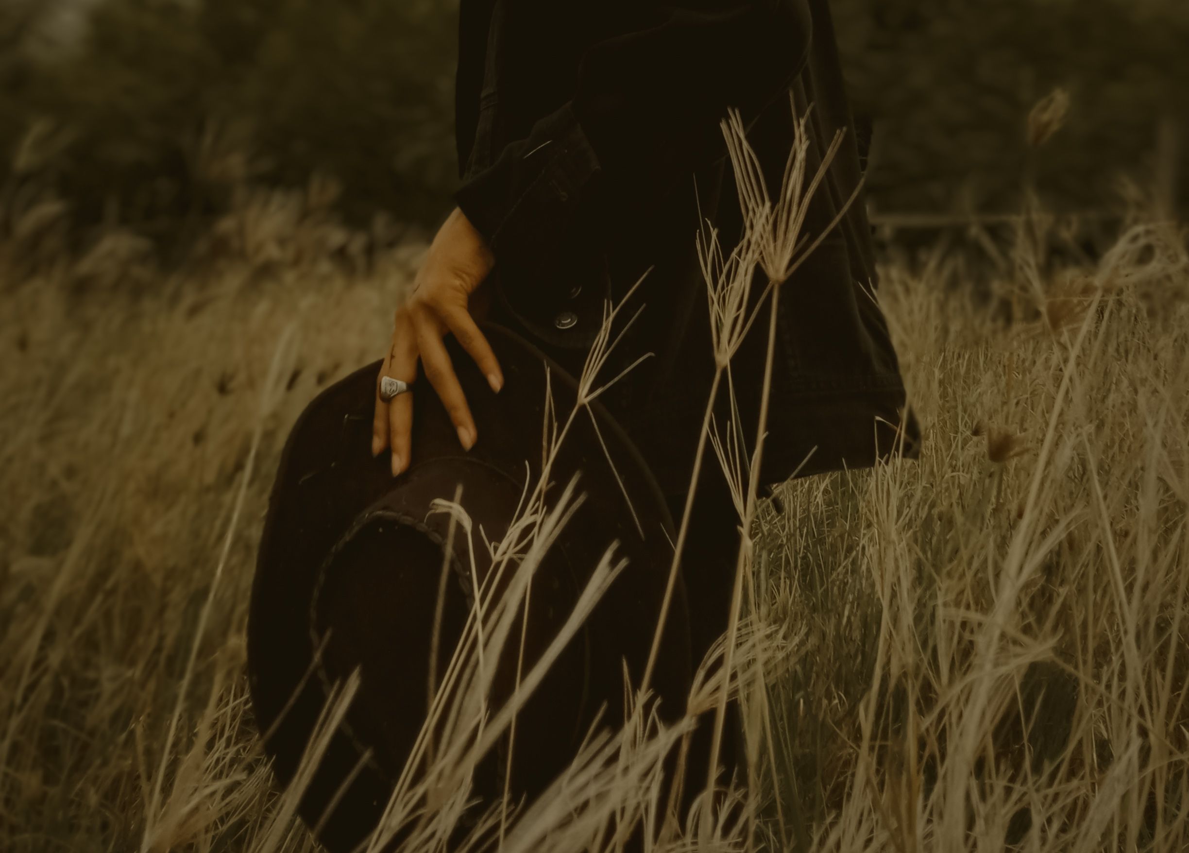 Photo of a Person's Hand Holding a Black Hat · Free Stock Photo