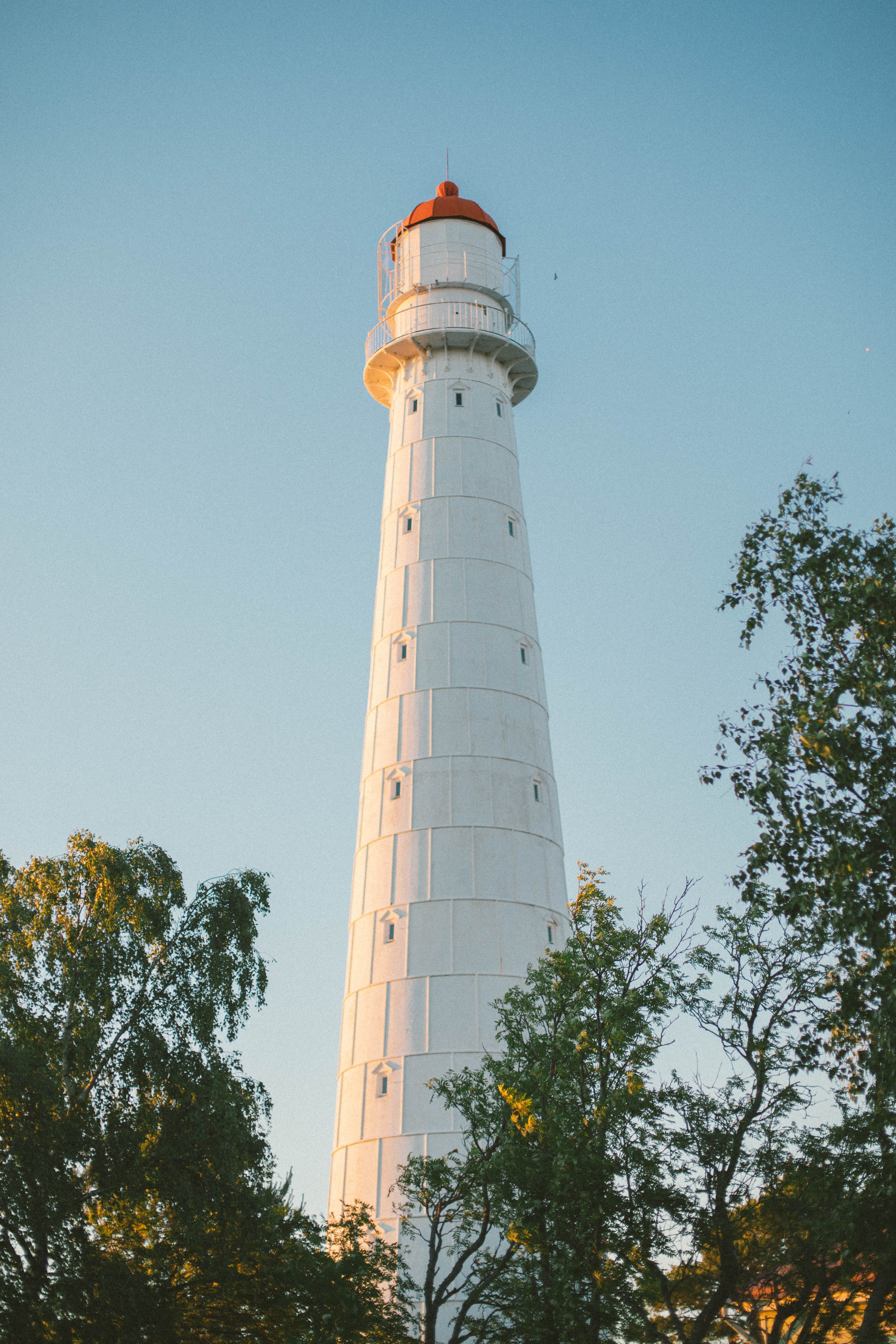 White Lighthouse Under White Sky · Free Stock Photo