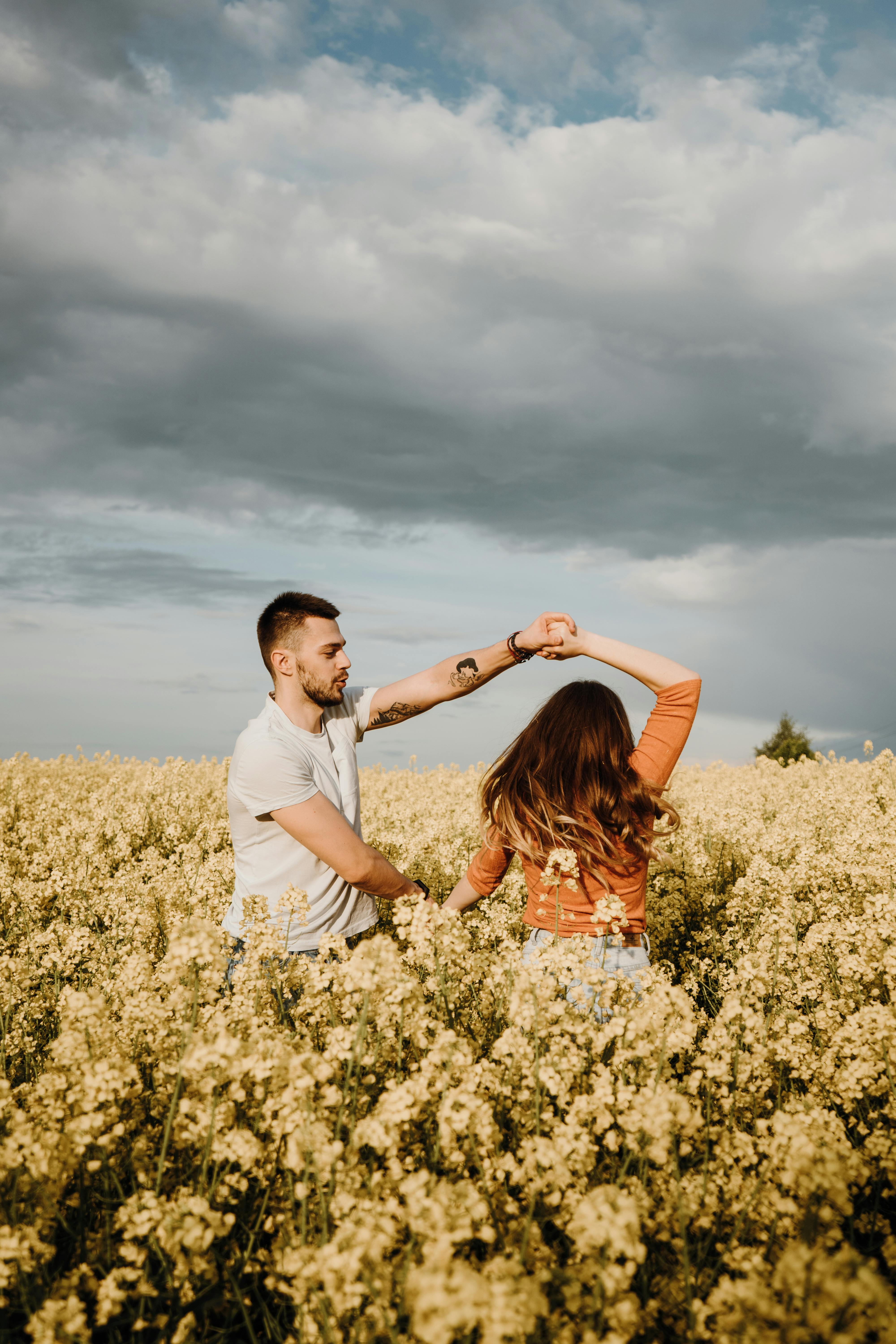 Young Couple Dancing in a Field · Free Stock Photo