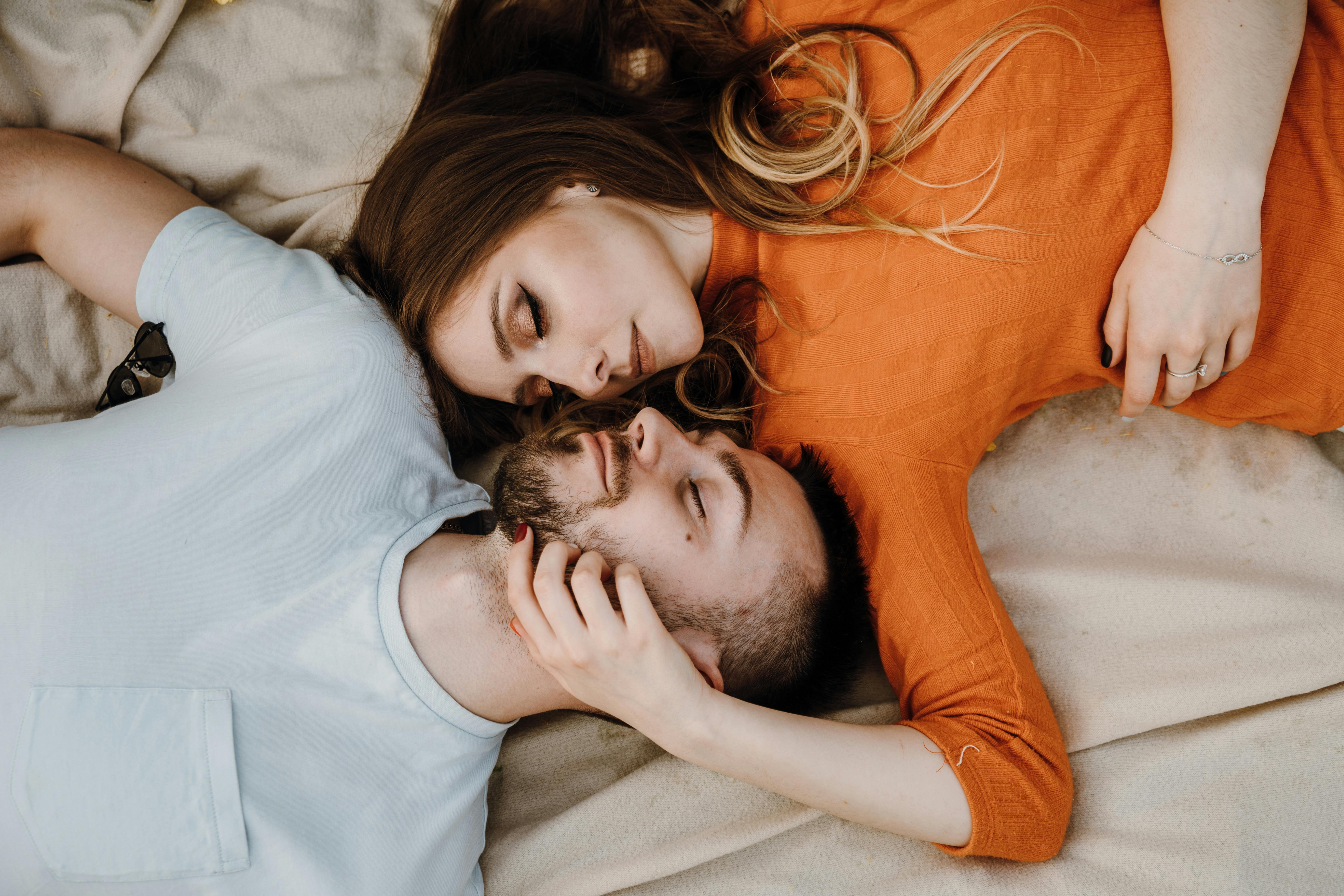 A Couple Lying Down on a Bed · Free Stock Photo