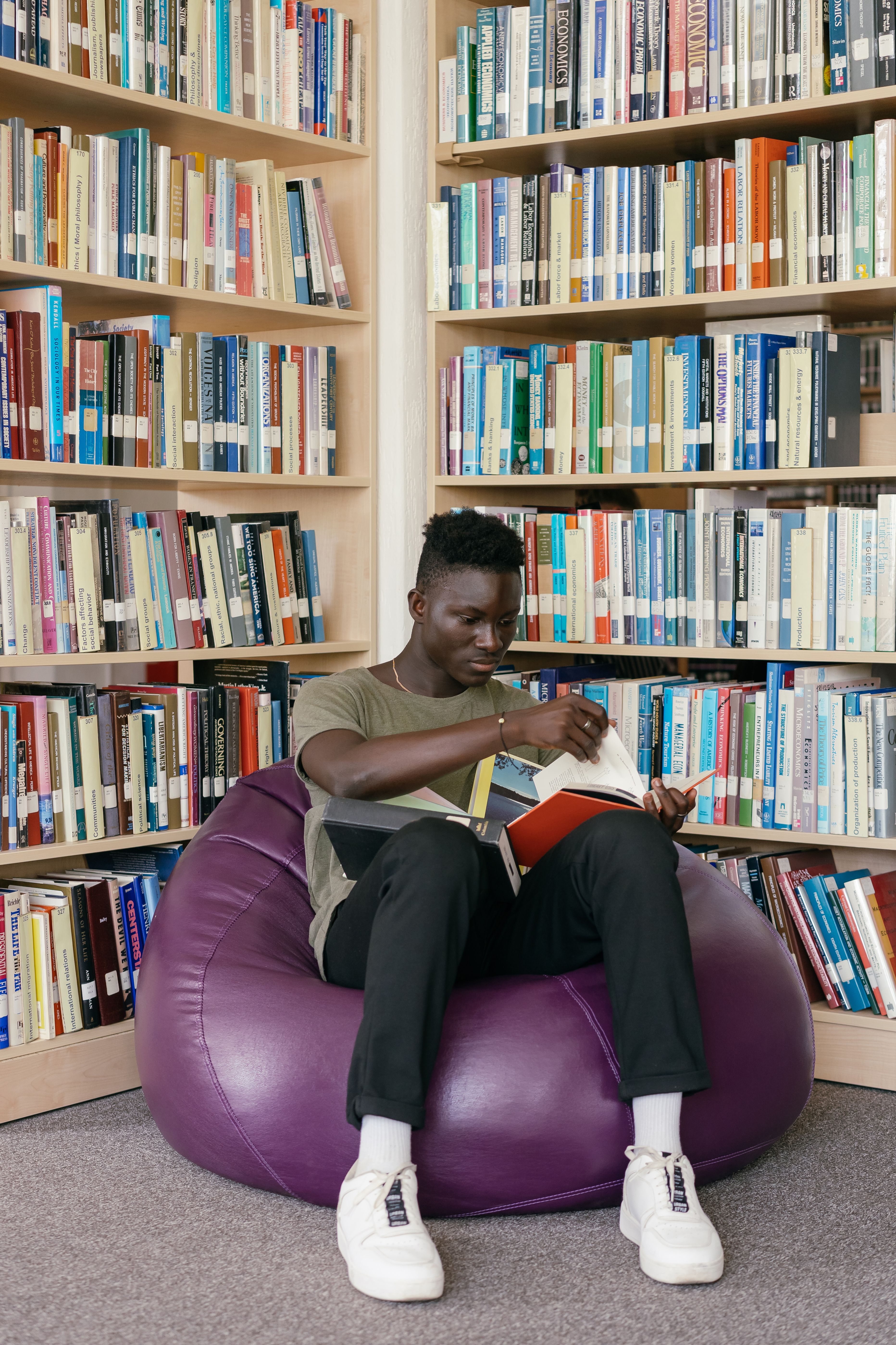 A Man Thinking while Sitting Inside the Library · Free Stock Photo