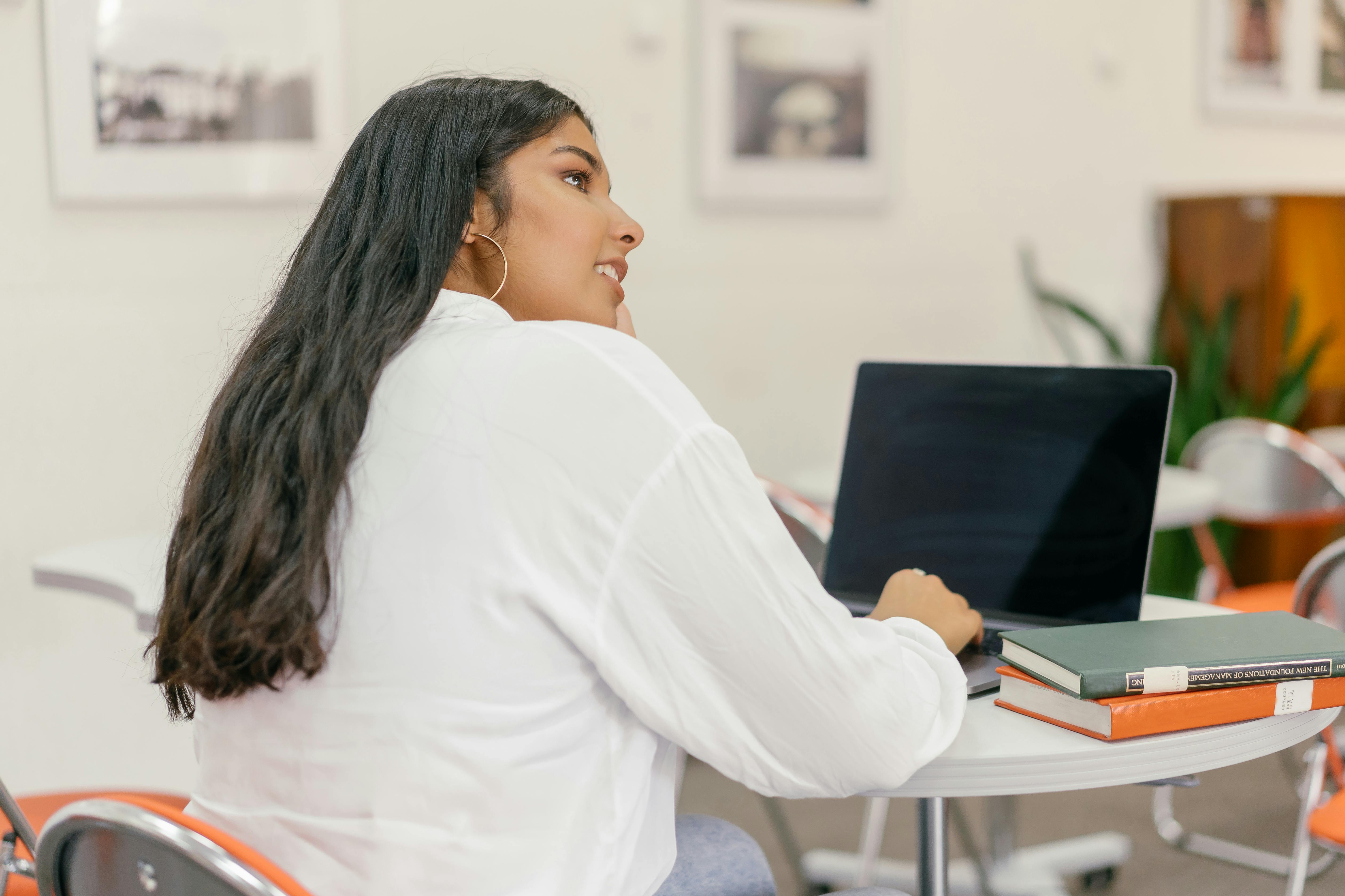 Female Student Sitting Near the Table · Free Stock Photo