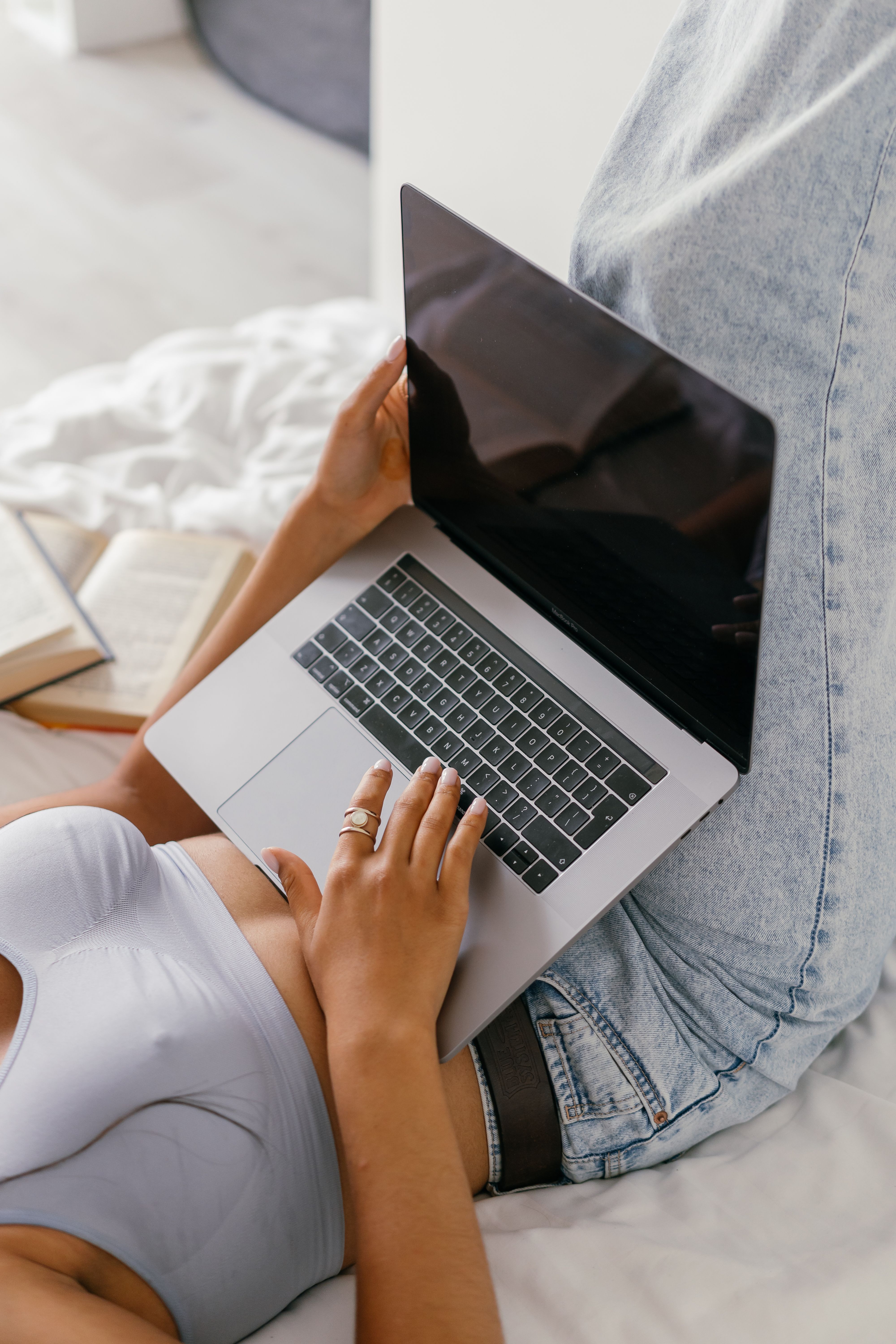 Close-Up Shot of a Woman Lying Down While Using a Laptop · Free Stock Photo
