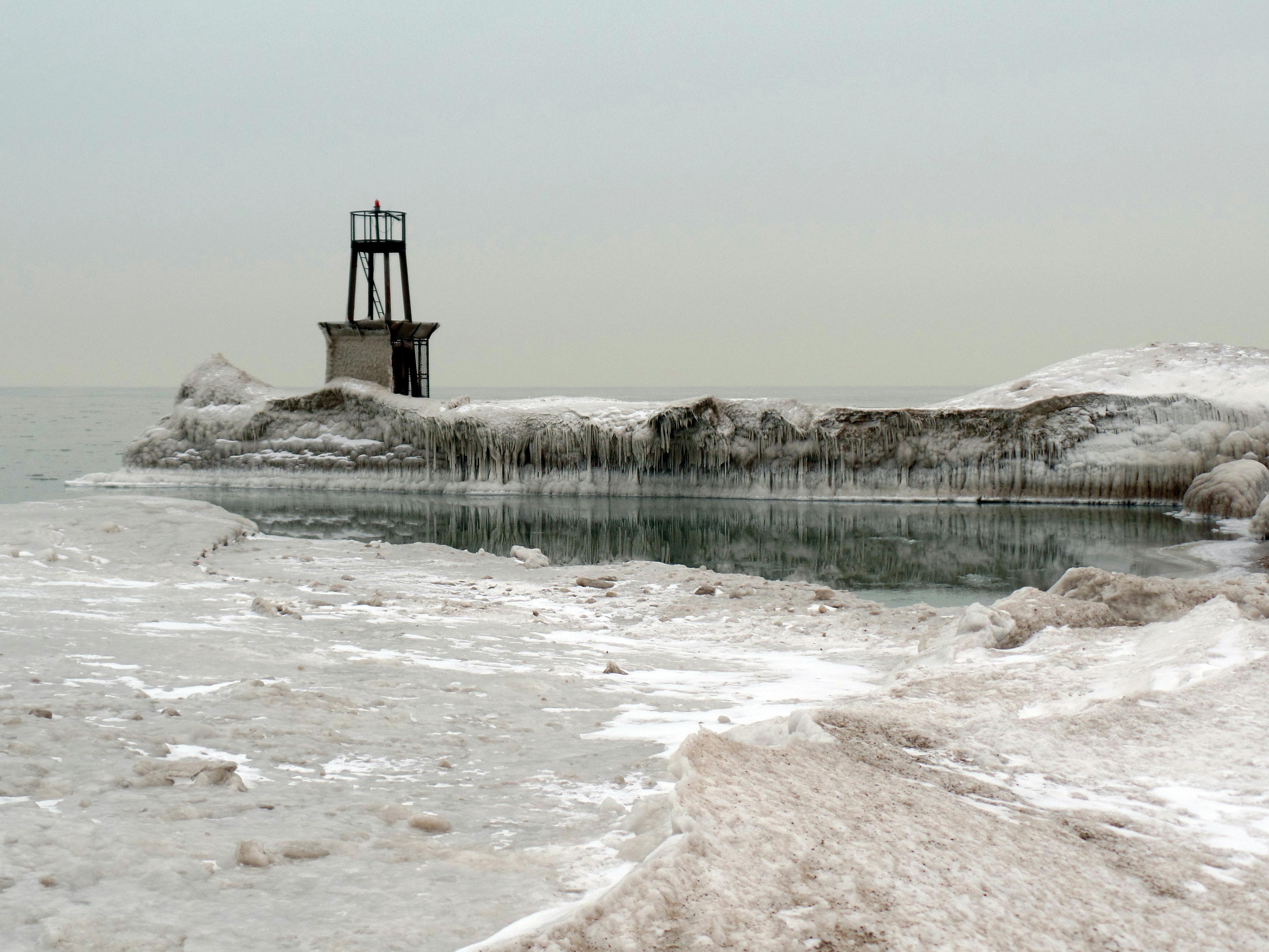 Rock and Mud on Sea Shore with Lighthouse behind at Sunset · Free Stock ...