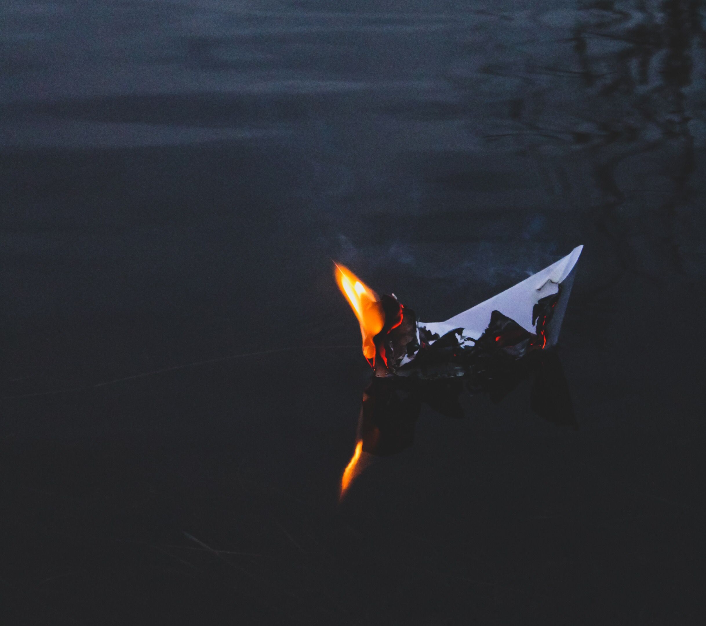 Origami Paper Boat Floating on Water and Burning in Dark · Free Stock Photo