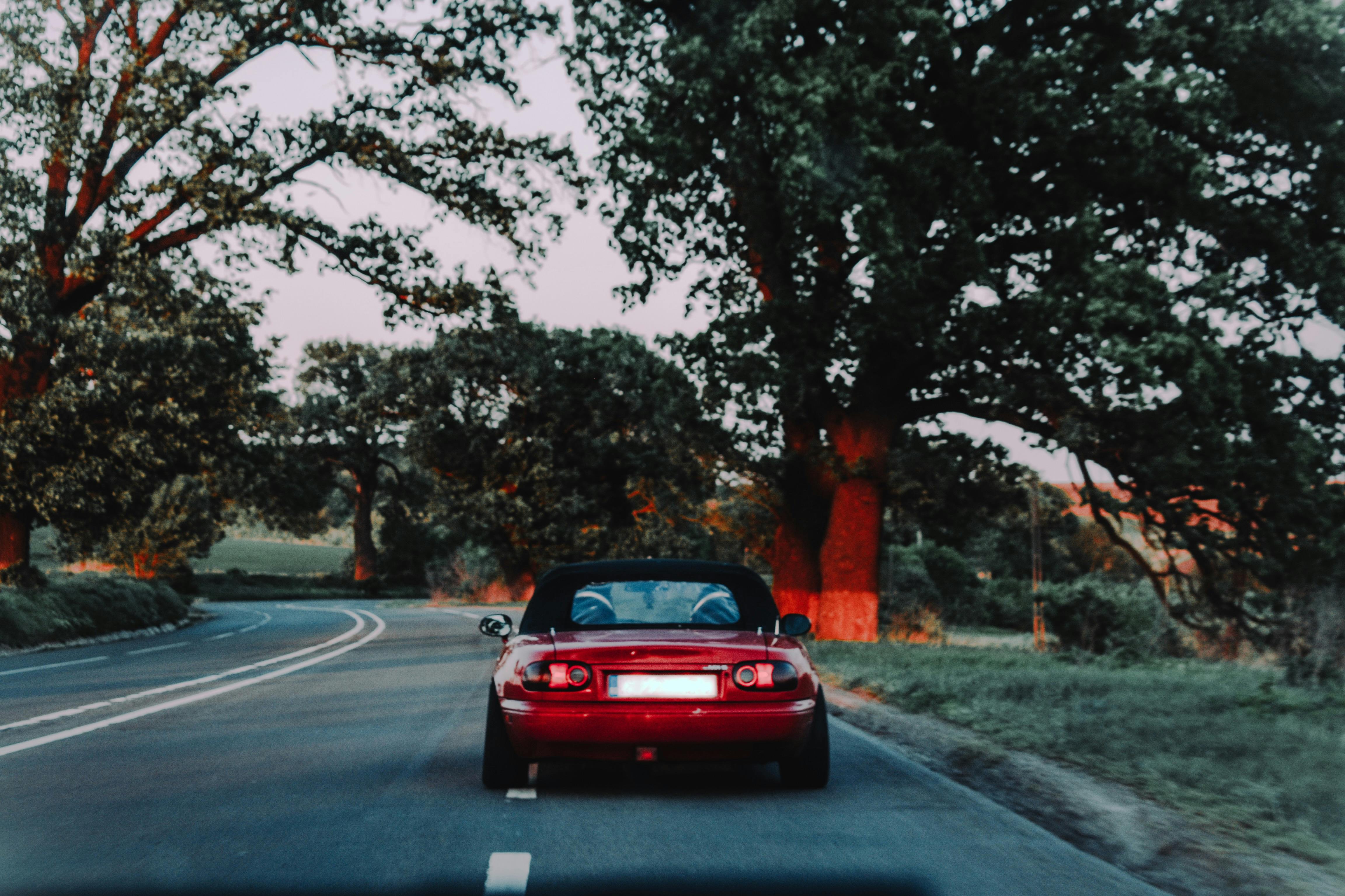 Photo of a Red Car on a Road · Free Stock Photo
