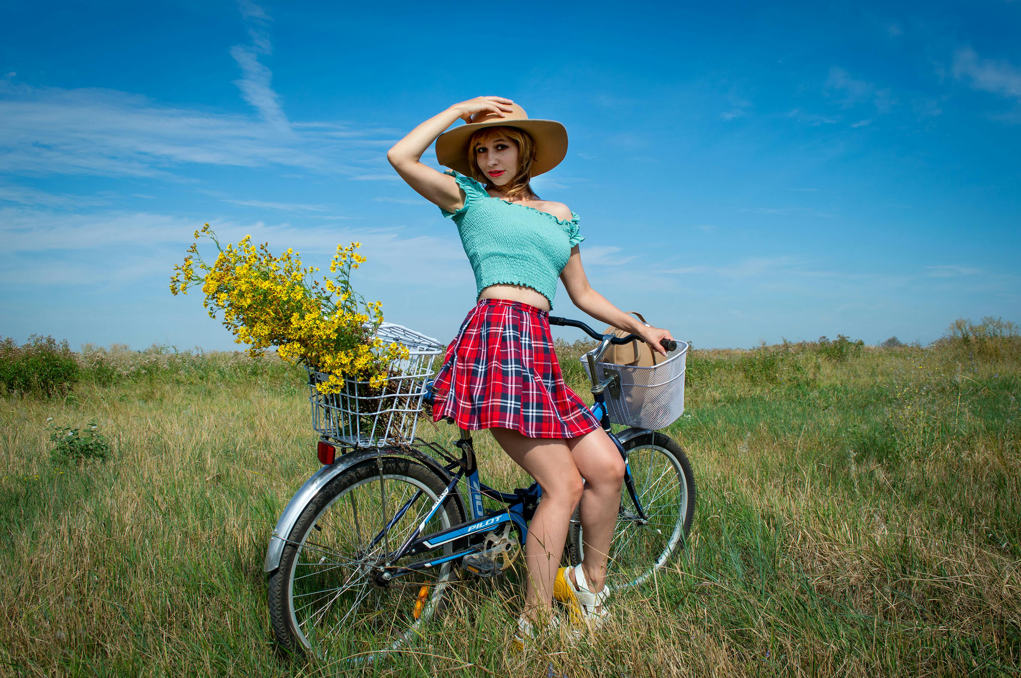 A Woman Wearing Off Shoulder Top and Fedora Hat Standing on the ...