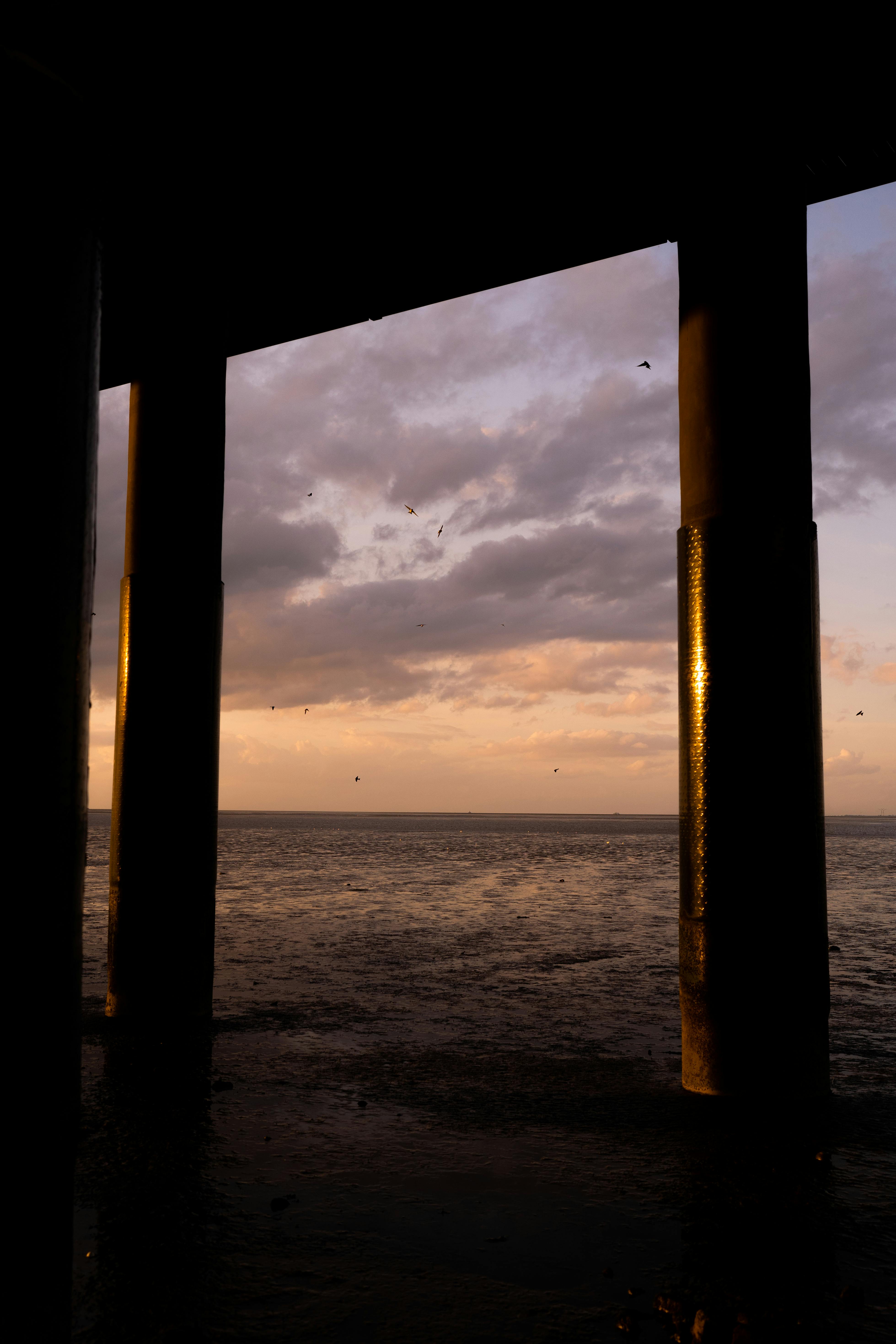 Body of Water Under Dark Clouds during Sunset · Free Stock Photo