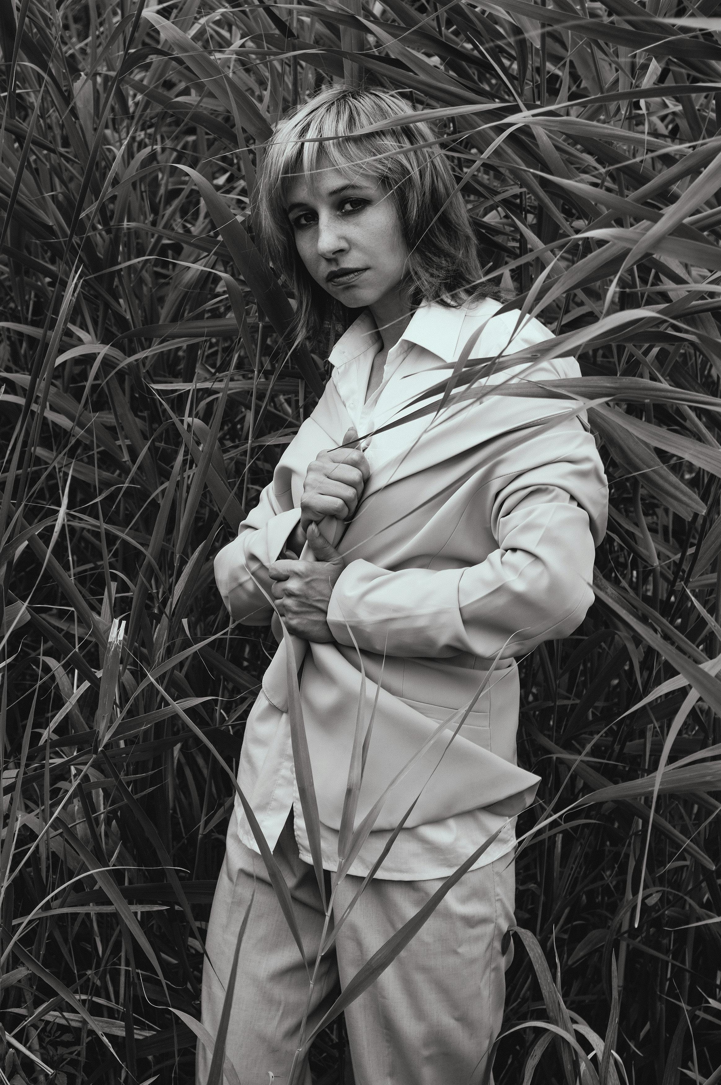 Grayscale Photo of a View of a Factory from a Grassland · Free Stock Photo