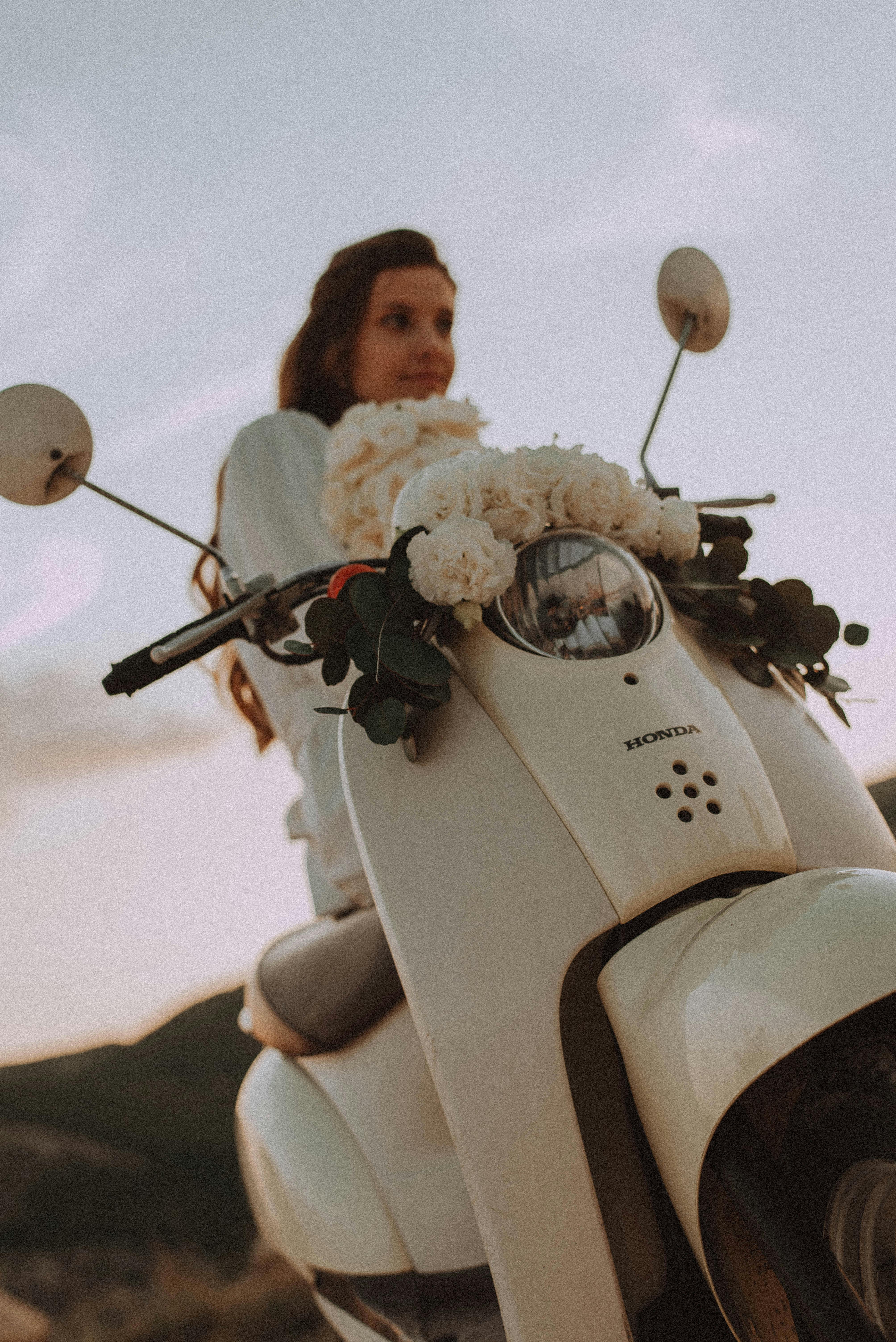A Woman Riding a Scooter · Free Stock Photo
