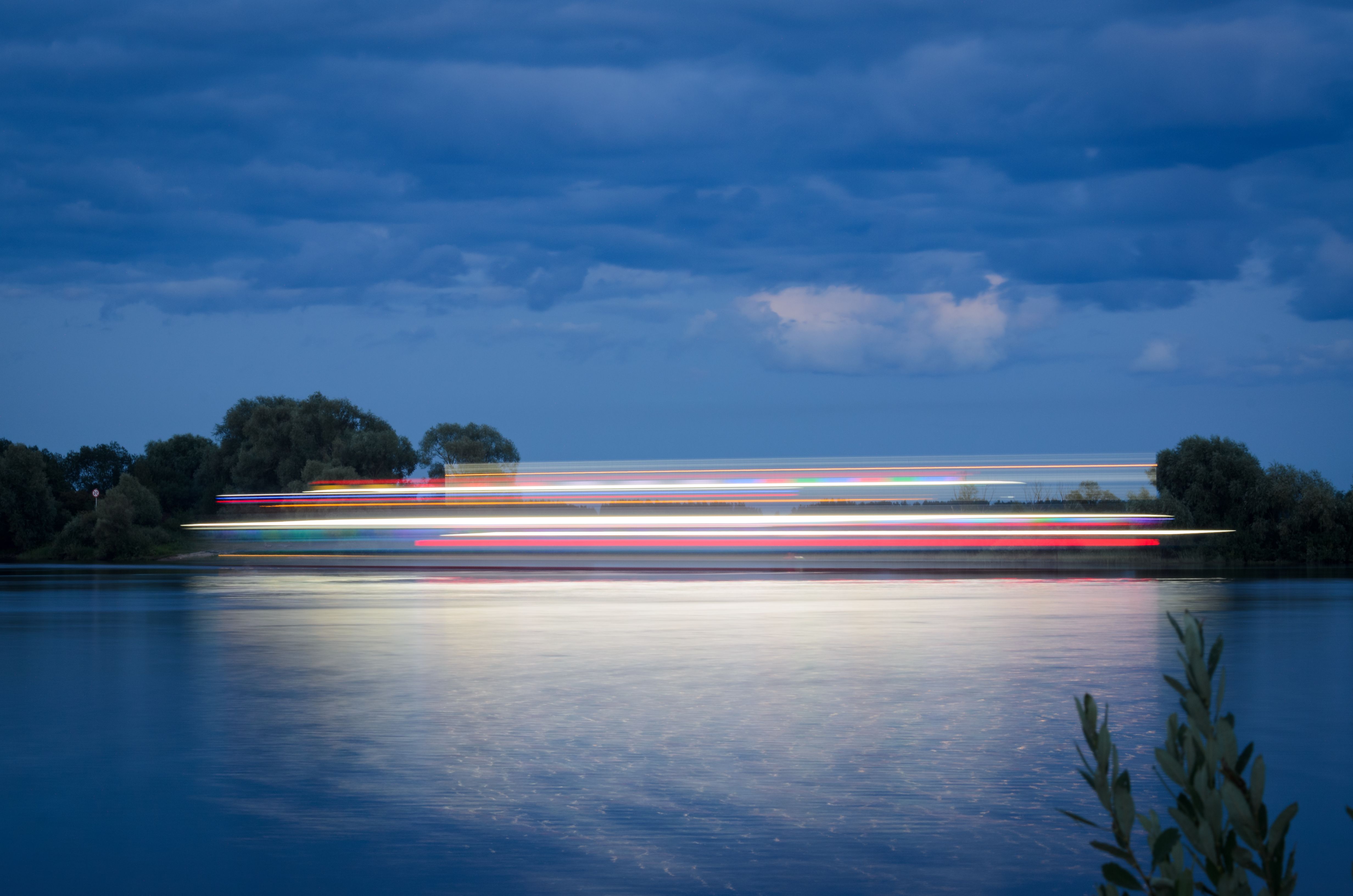 Motion Blur of Boat Sailing Across Lake · Free Stock Photo