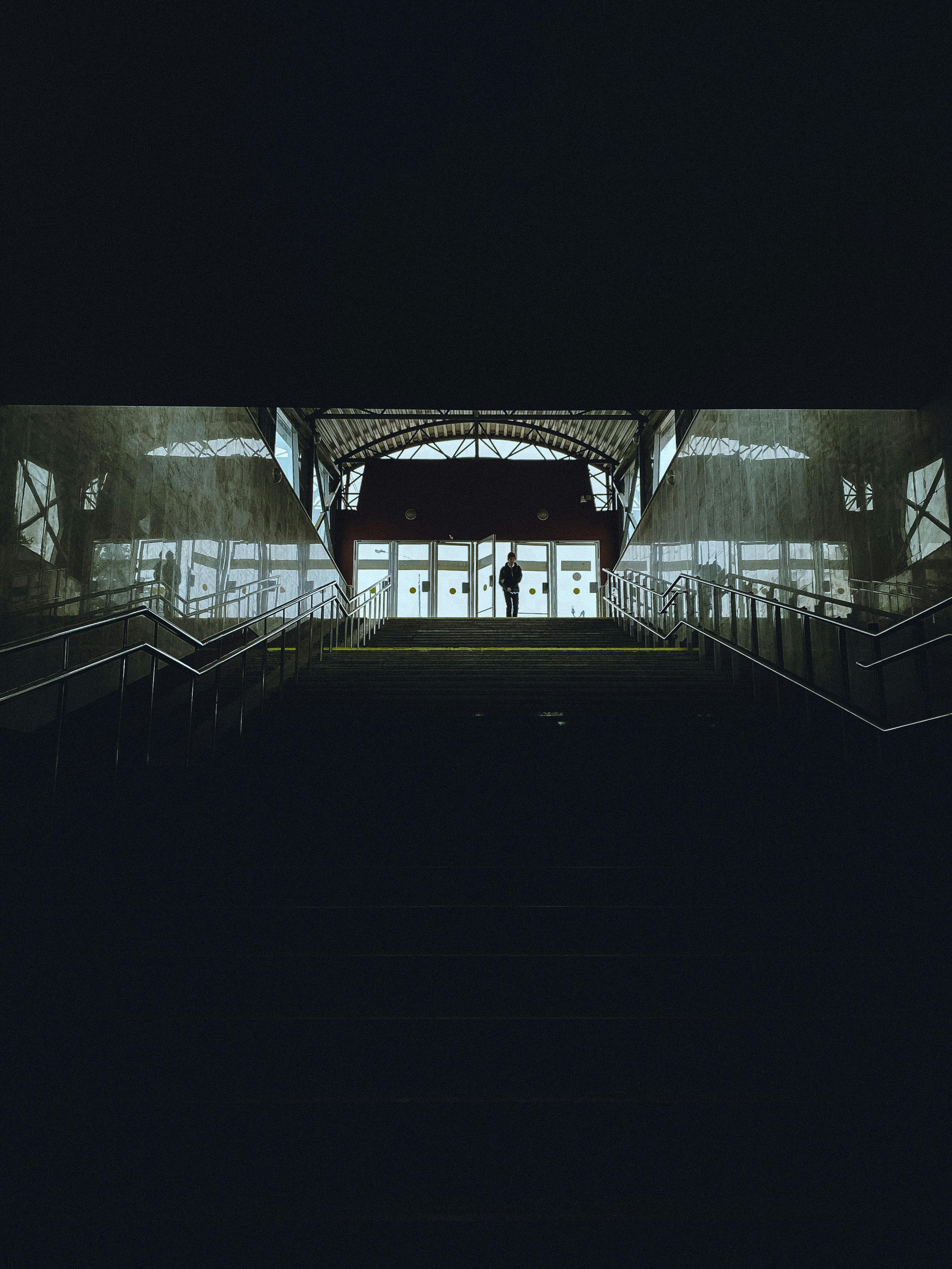 Person Entering Building with Dark Steps · Free Stock Photo