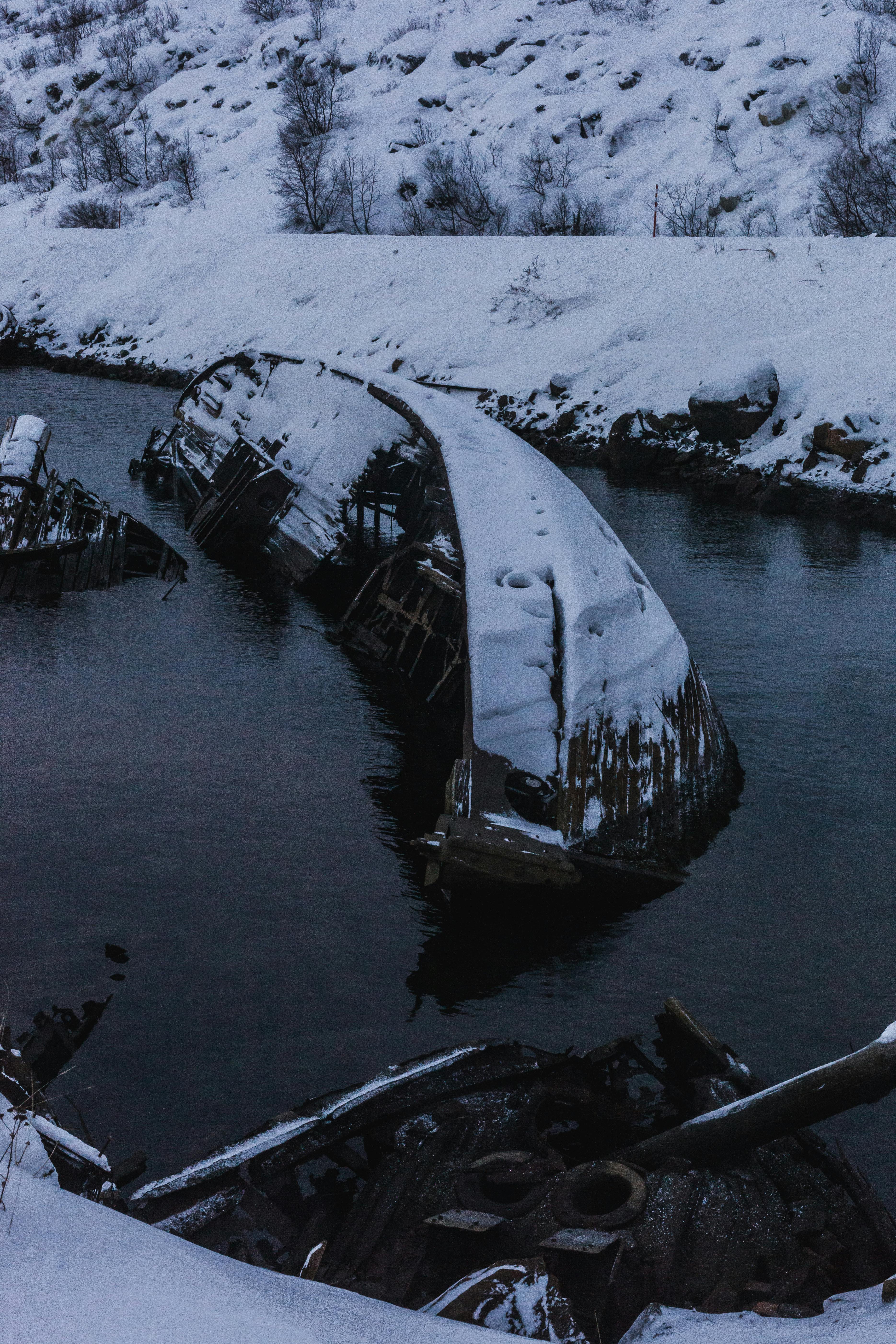 A Sinking Snow Covered Boat on a Lake · Free Stock Photo