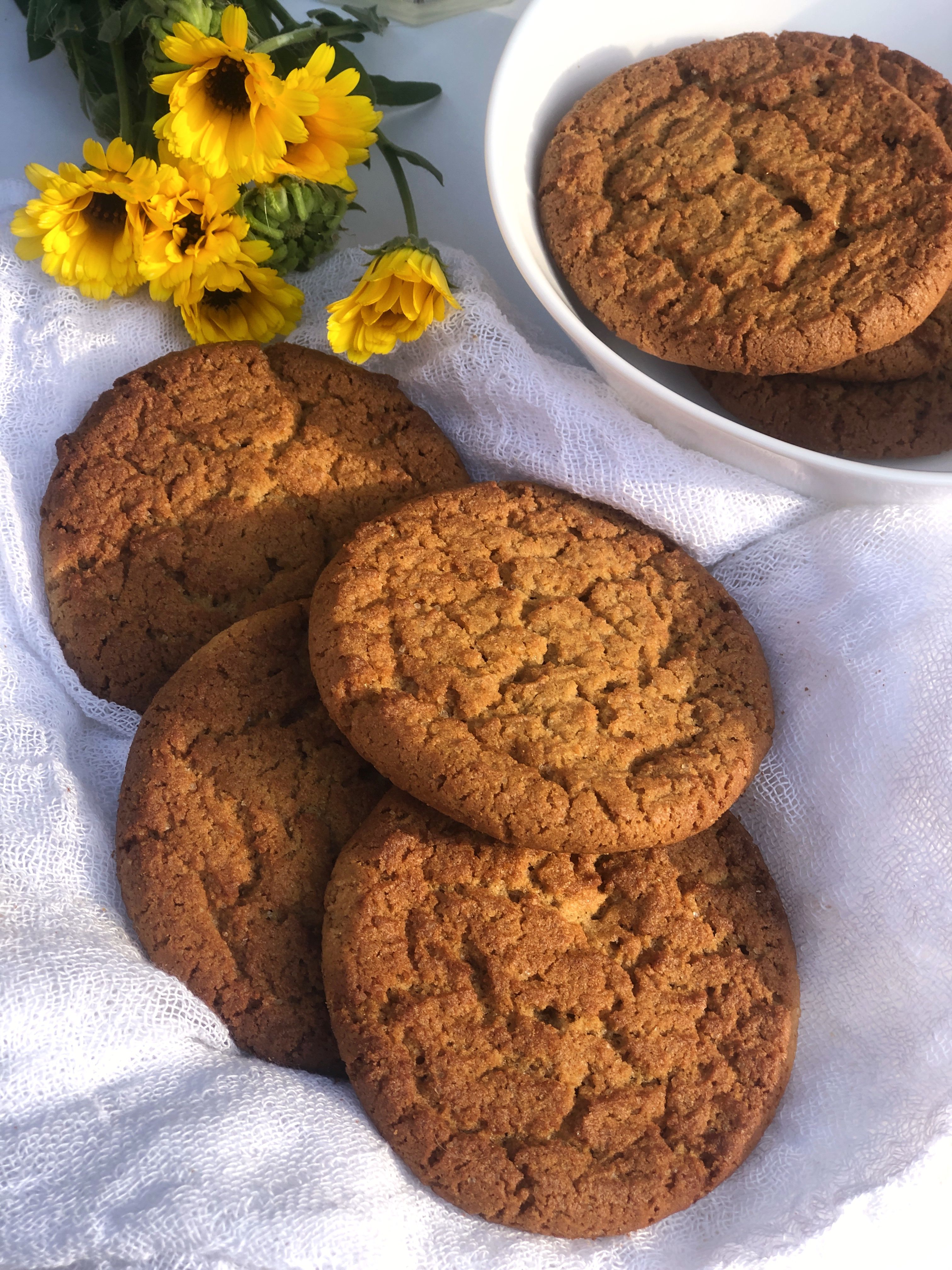 Brown Cookies Beside Bunch of Beautiful Yellow Flowers · Free Stock Photo