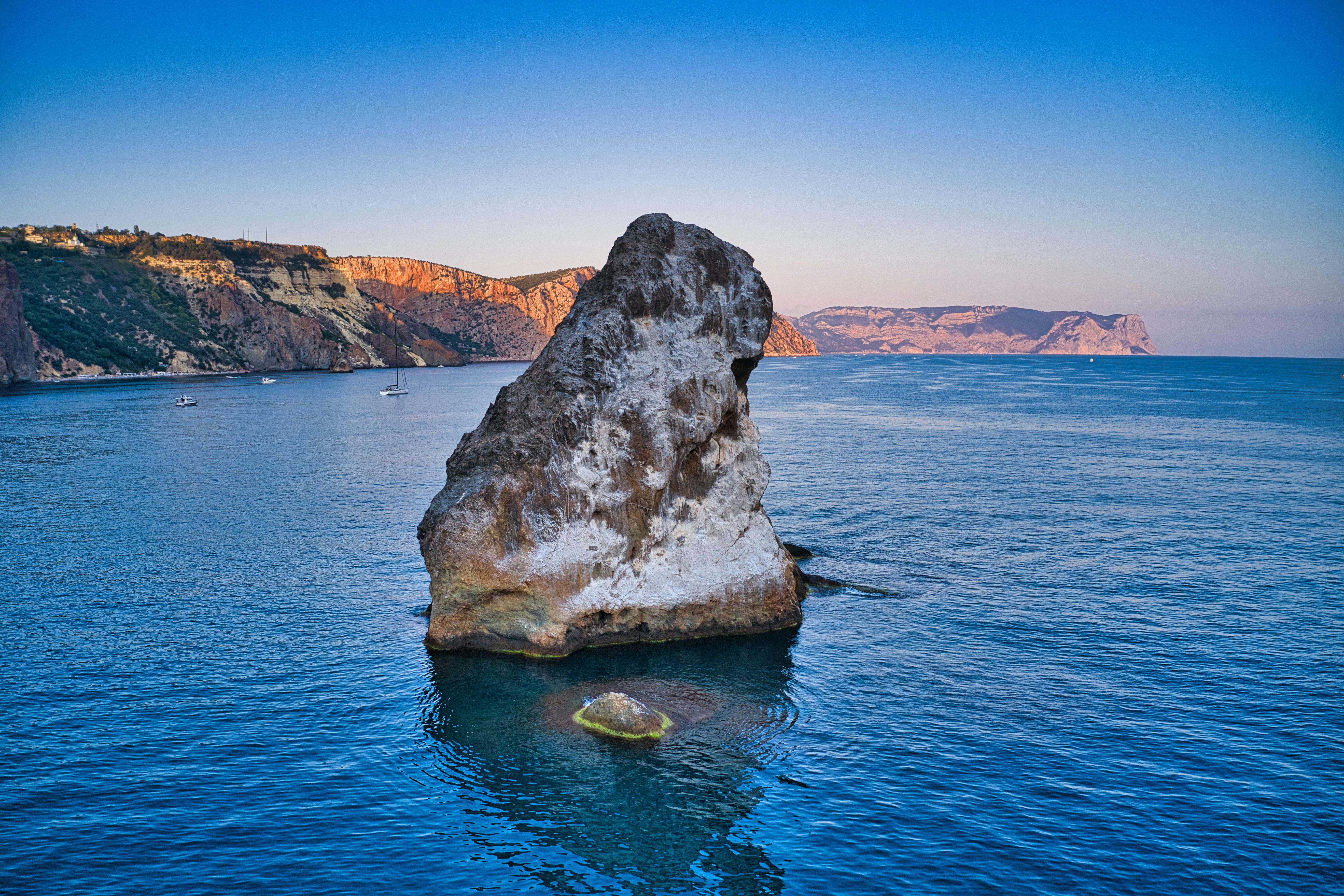 Big Rock Formation on the Middle of the Sea Under Blue Sky · Free Stock ...