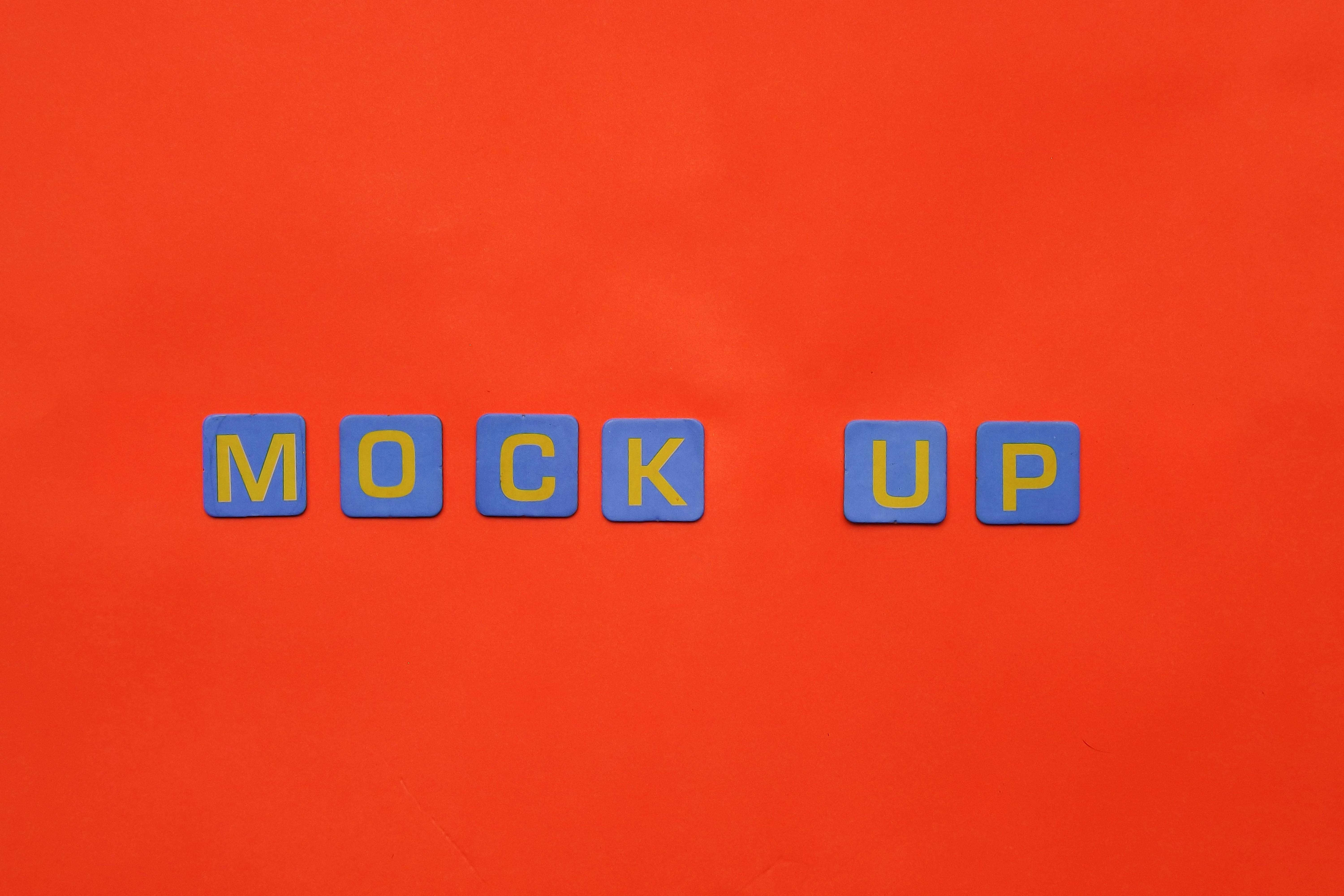 Close-Up Shot of Text on a Red Surface · Free Stock Photo