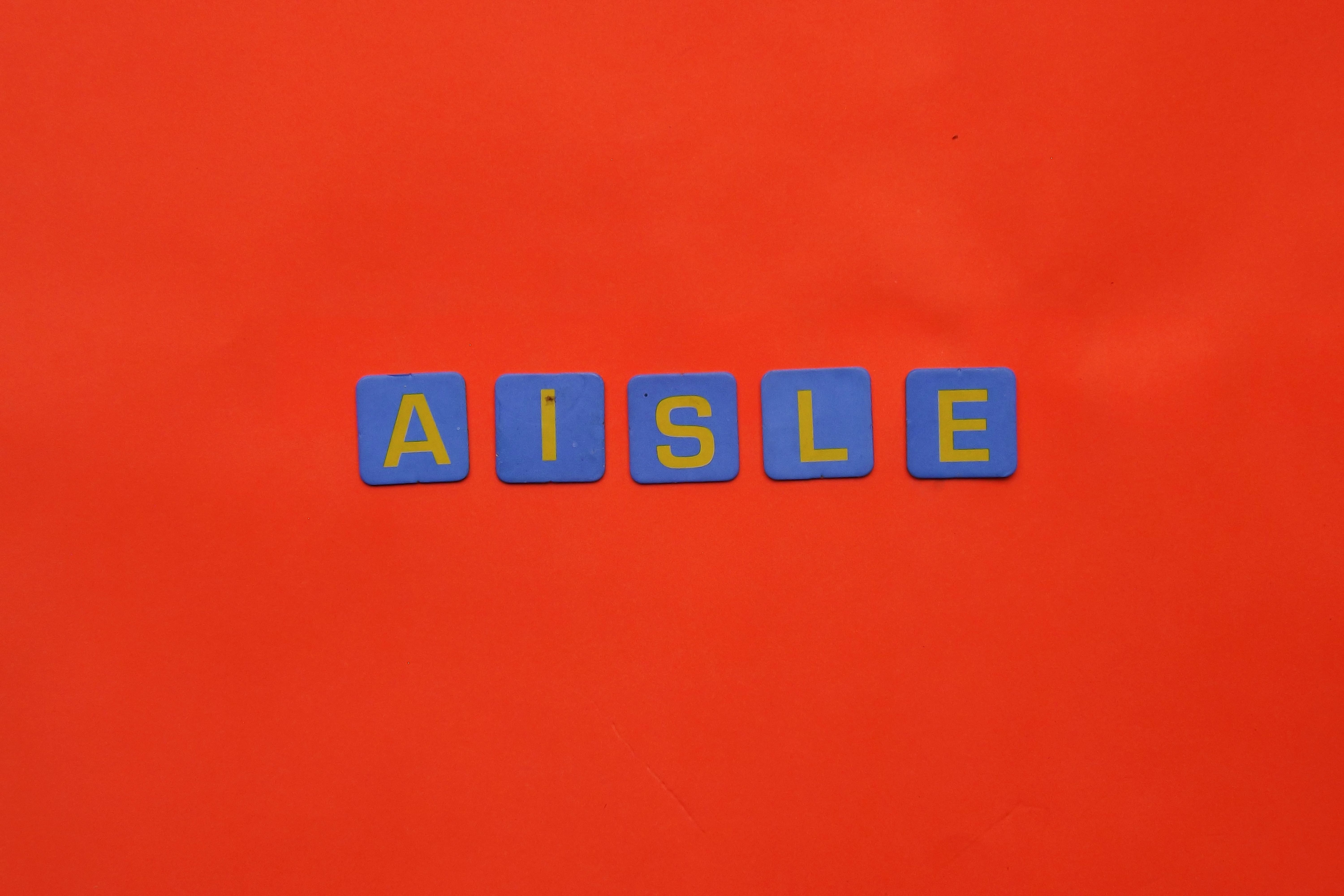 Close-Up Shot of Scrabble Tiles on a Blue Surface · Free Stock Photo