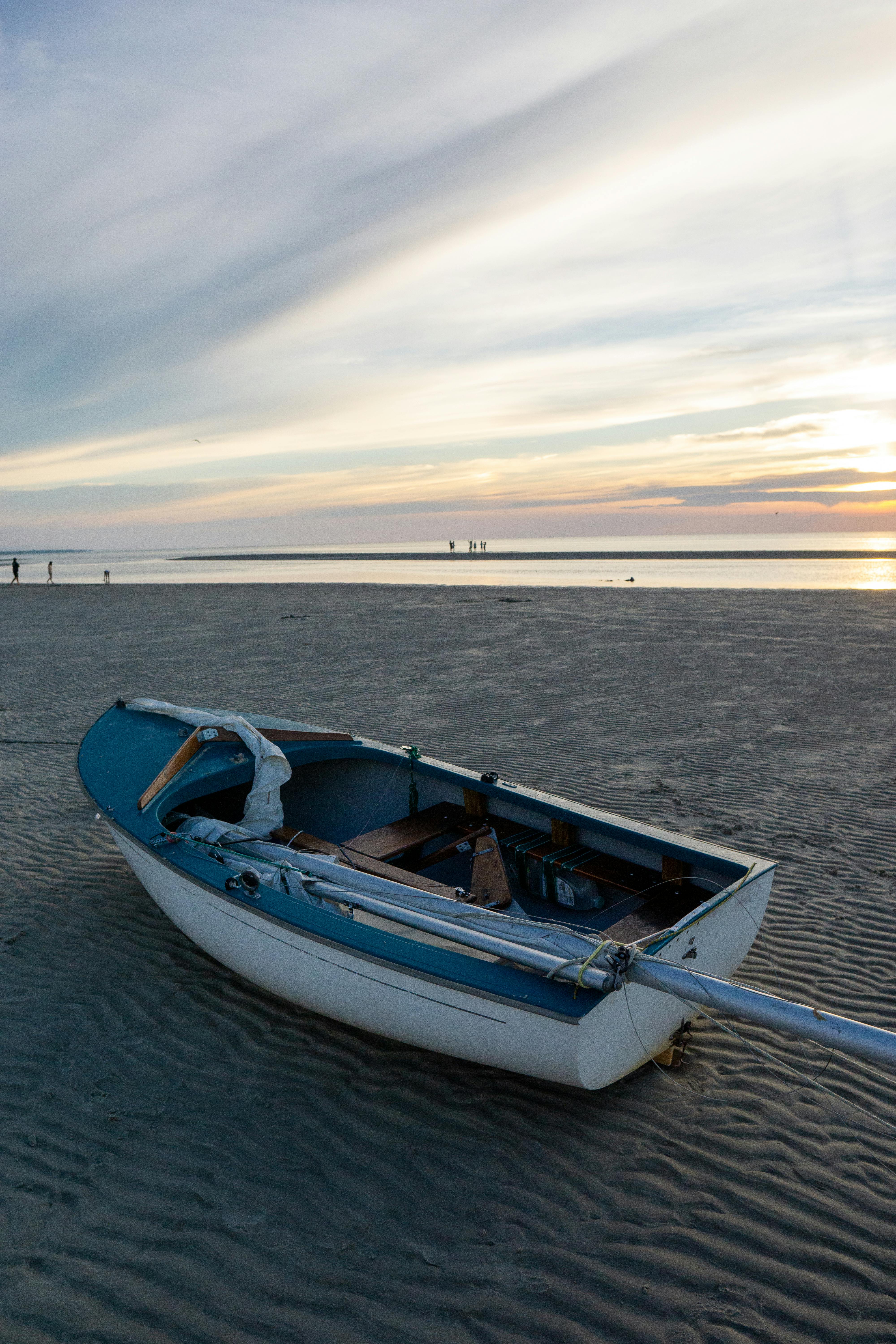 A Wooden Boat on a Beach Sand · Free Stock Photo