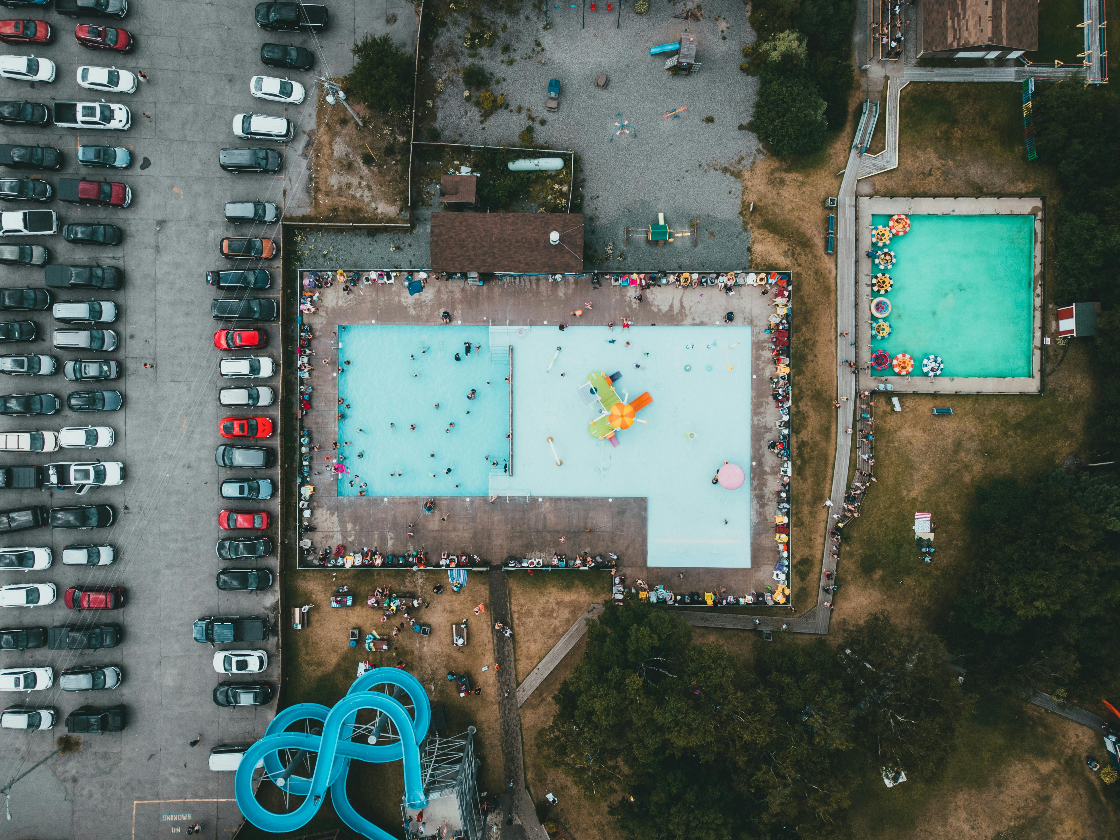 Aerial View of a Swimming Pool Near the Carpark · Free Stock Photo