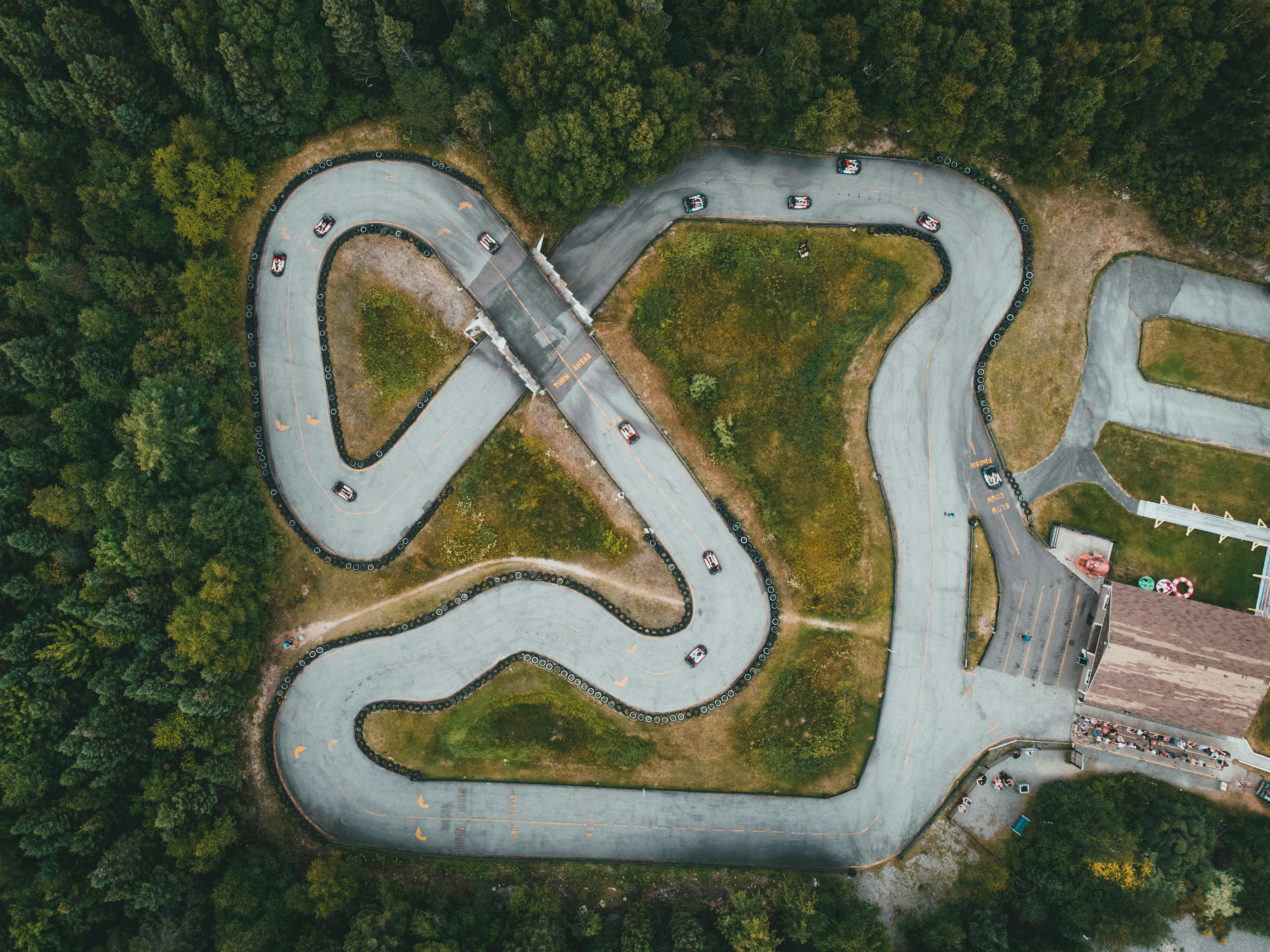 Aerial View of Race Track Surrounded by Green Trees · Free Stock Photo