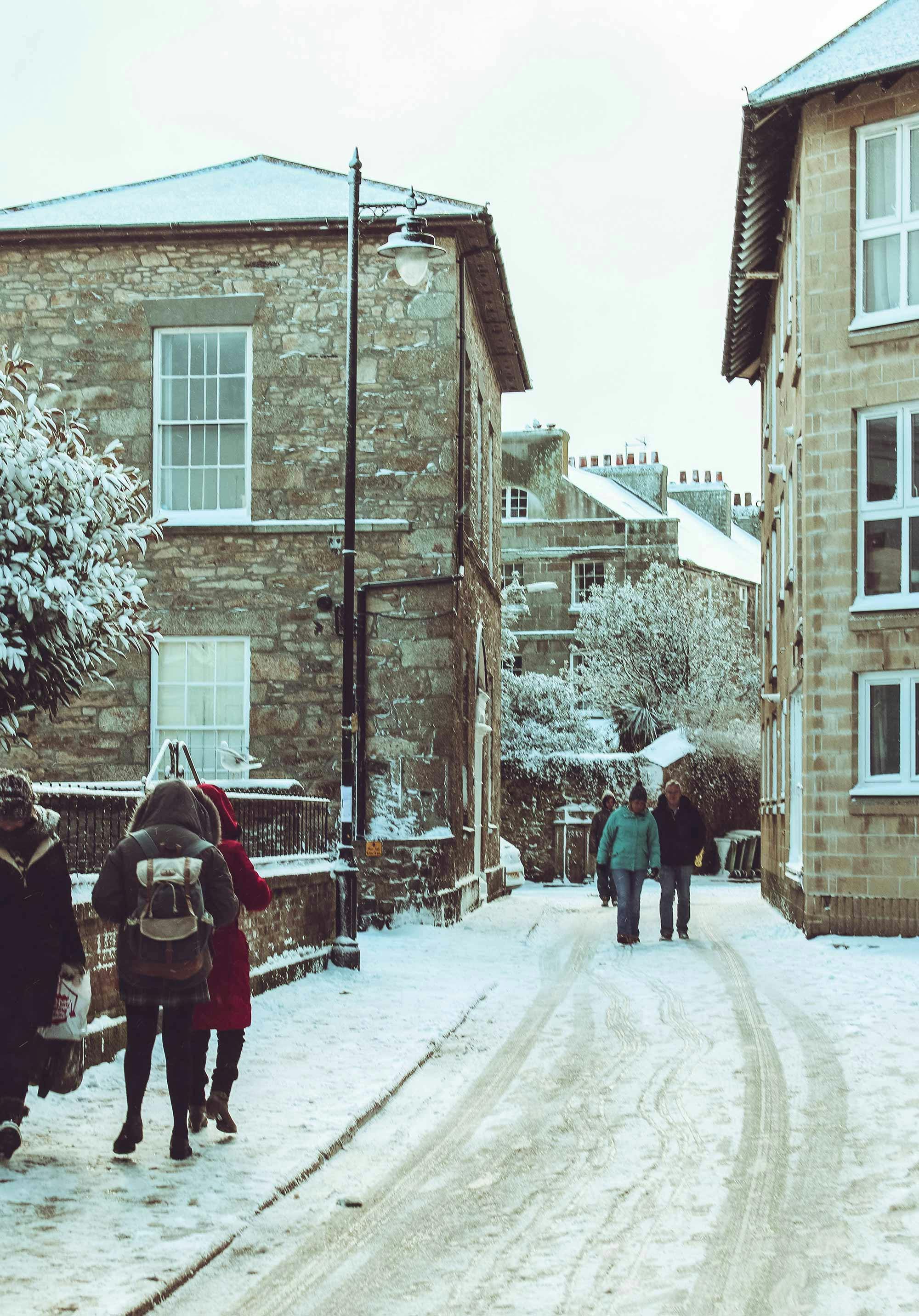 People Walking on Snow Covered Street · Free Stock Photo