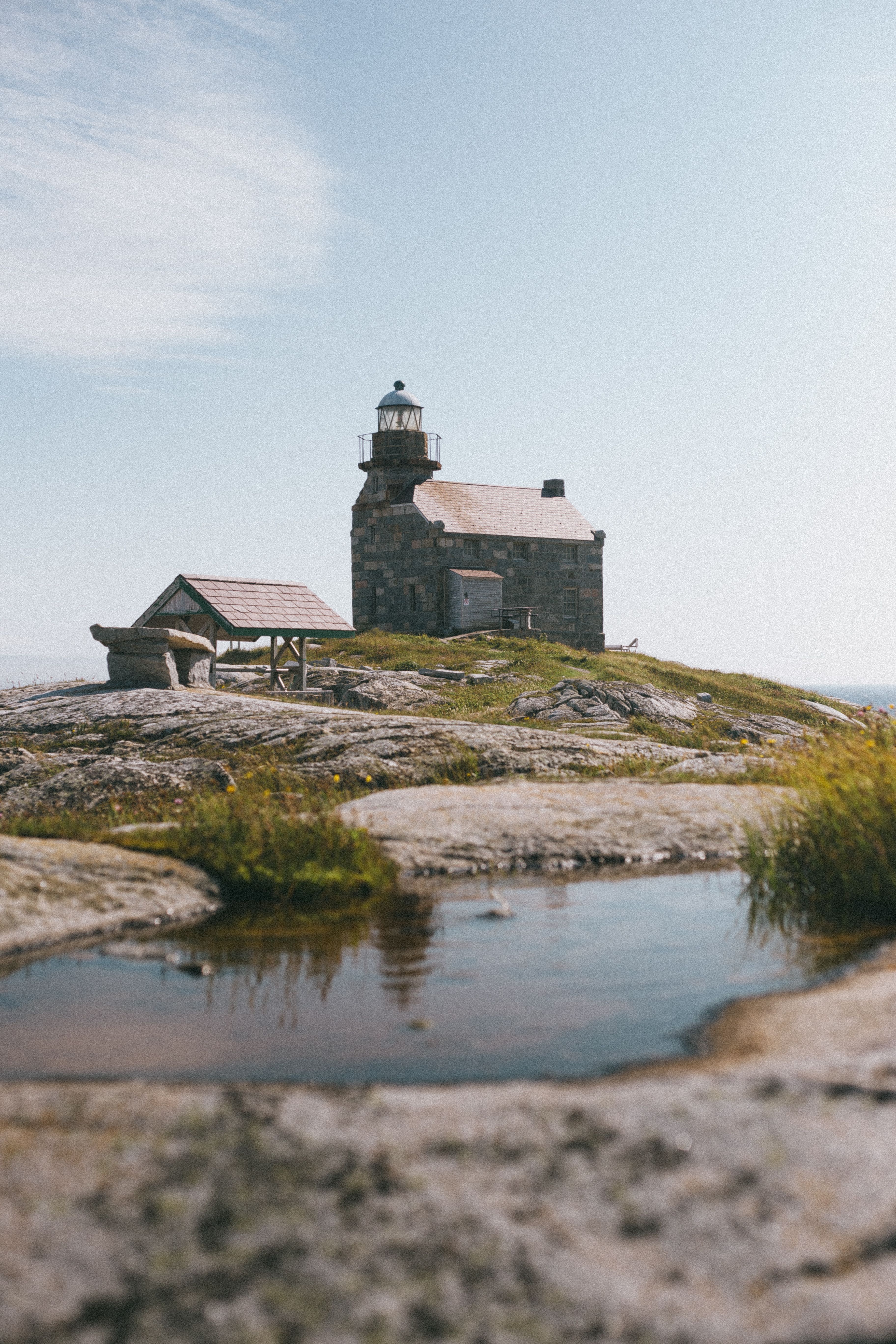 Old Stone Lighthouse on Sea Shore · Free Stock Photo