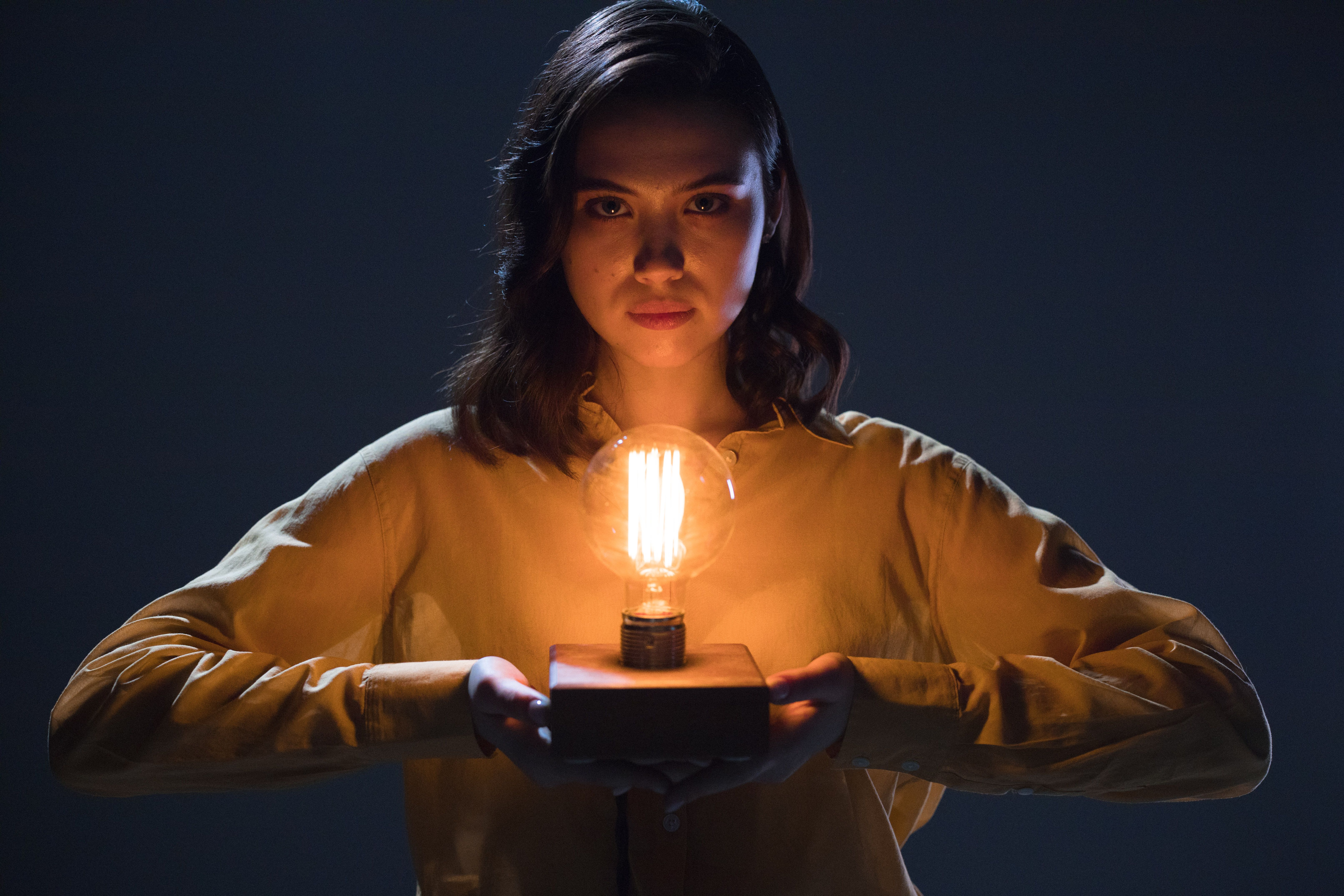 Woman Holding an Incandescent Light Bulb · Free Stock Photo
