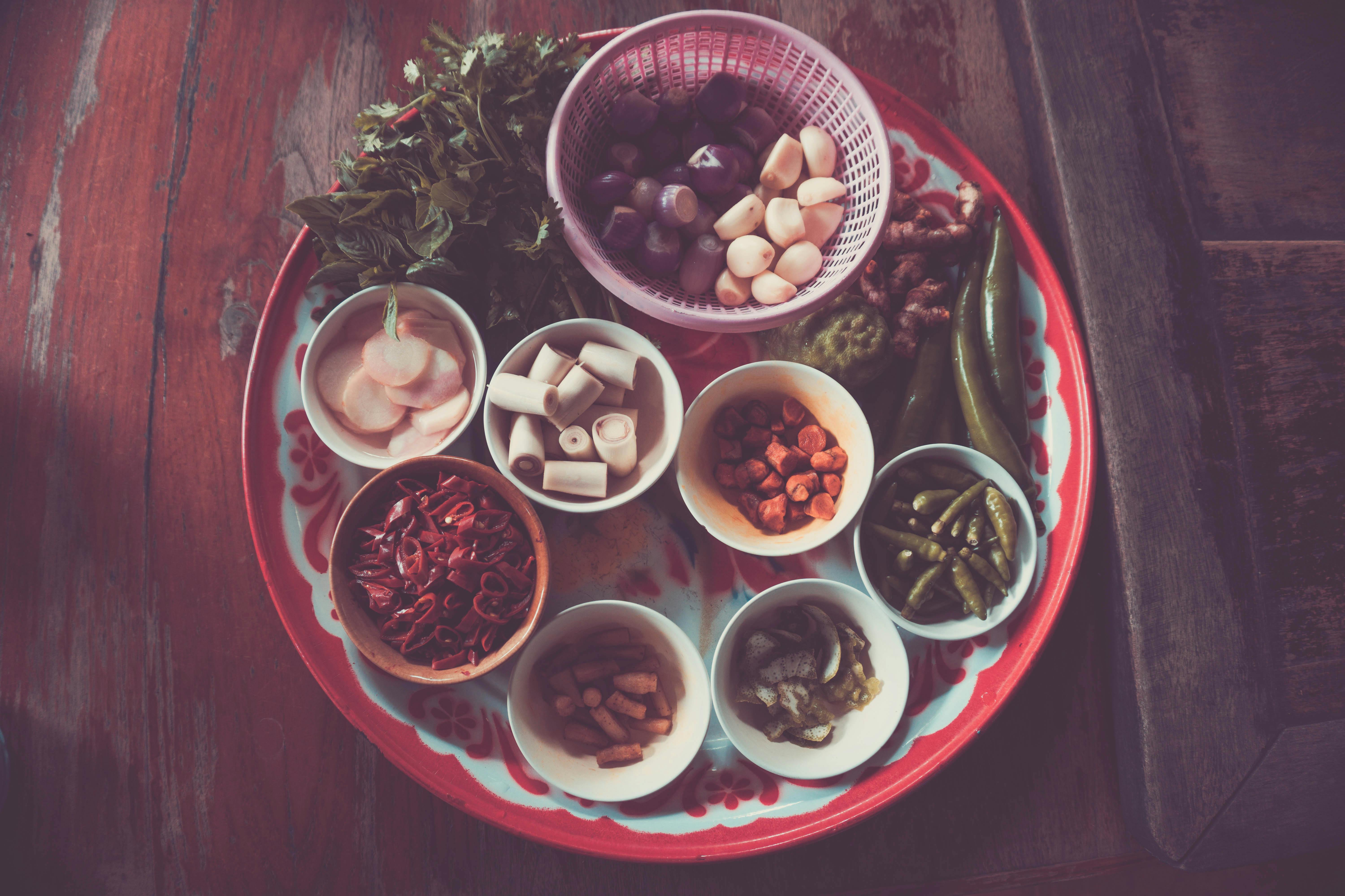 Assorted Spices on White and Red Plate on Brown Wooden Table · Free ...