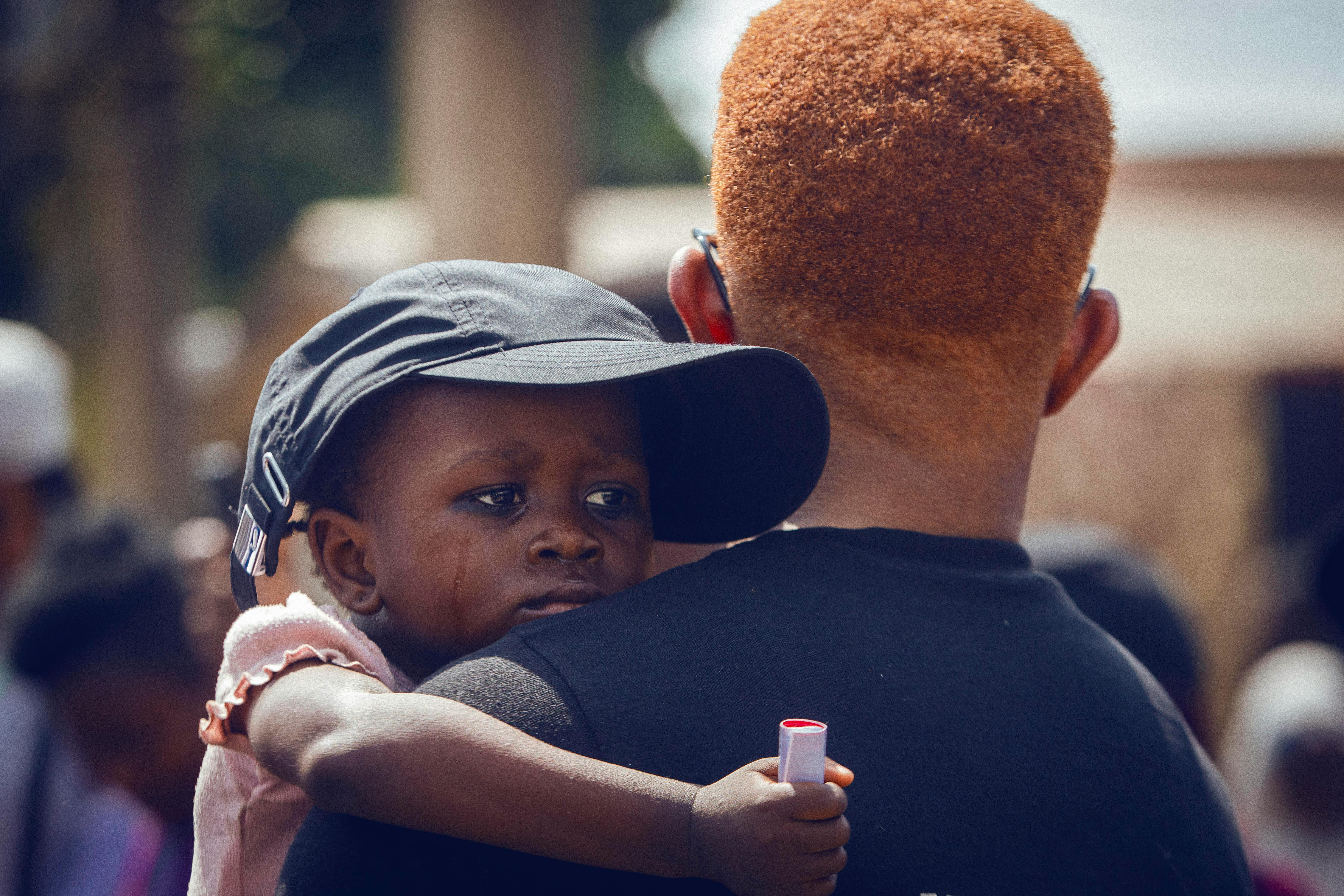Sad Woman Comforting A Scaring Child By Hugging Her From Back Photos ...